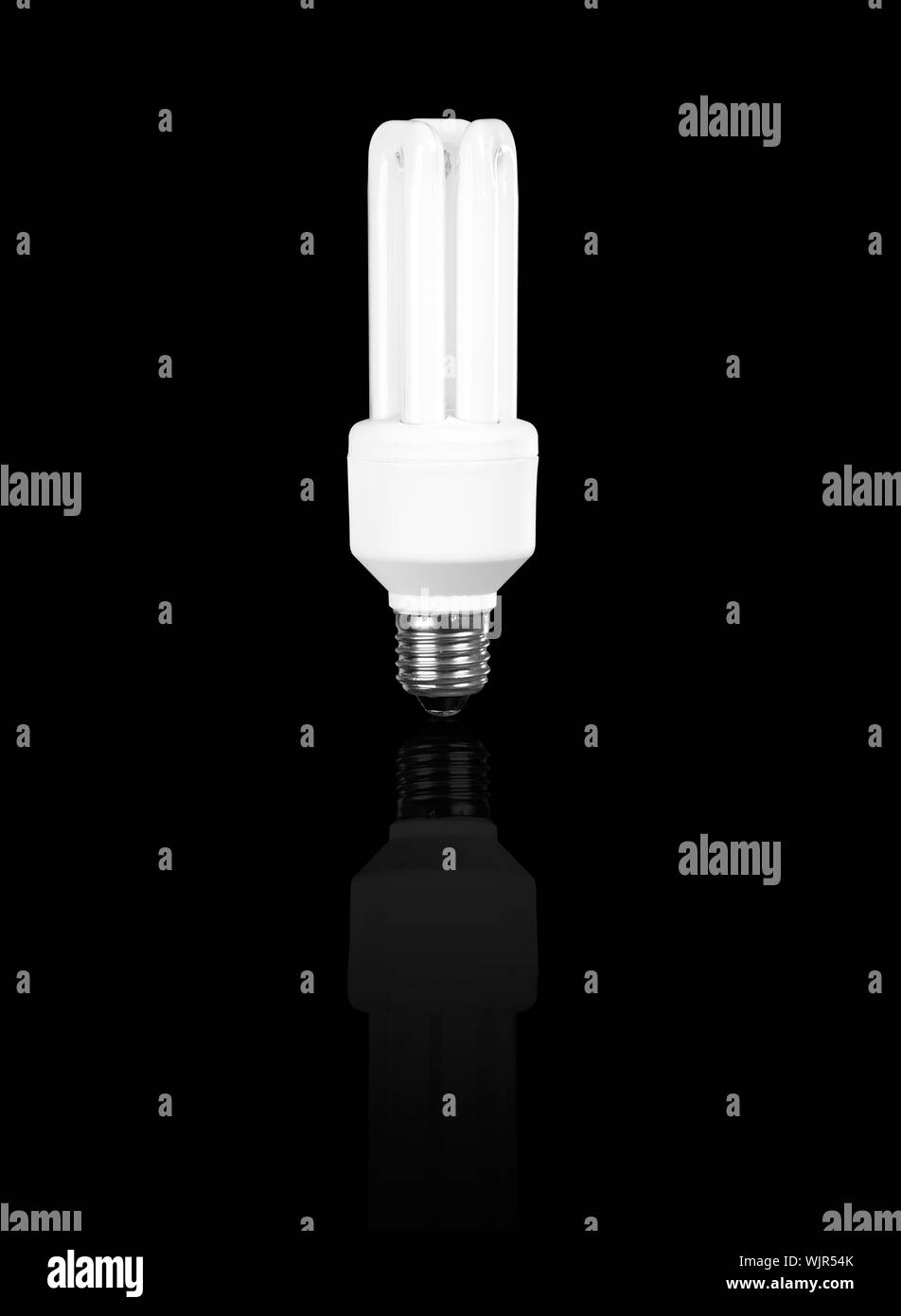 Fluorescent Light Bulb on a black background with reflection C energy ...