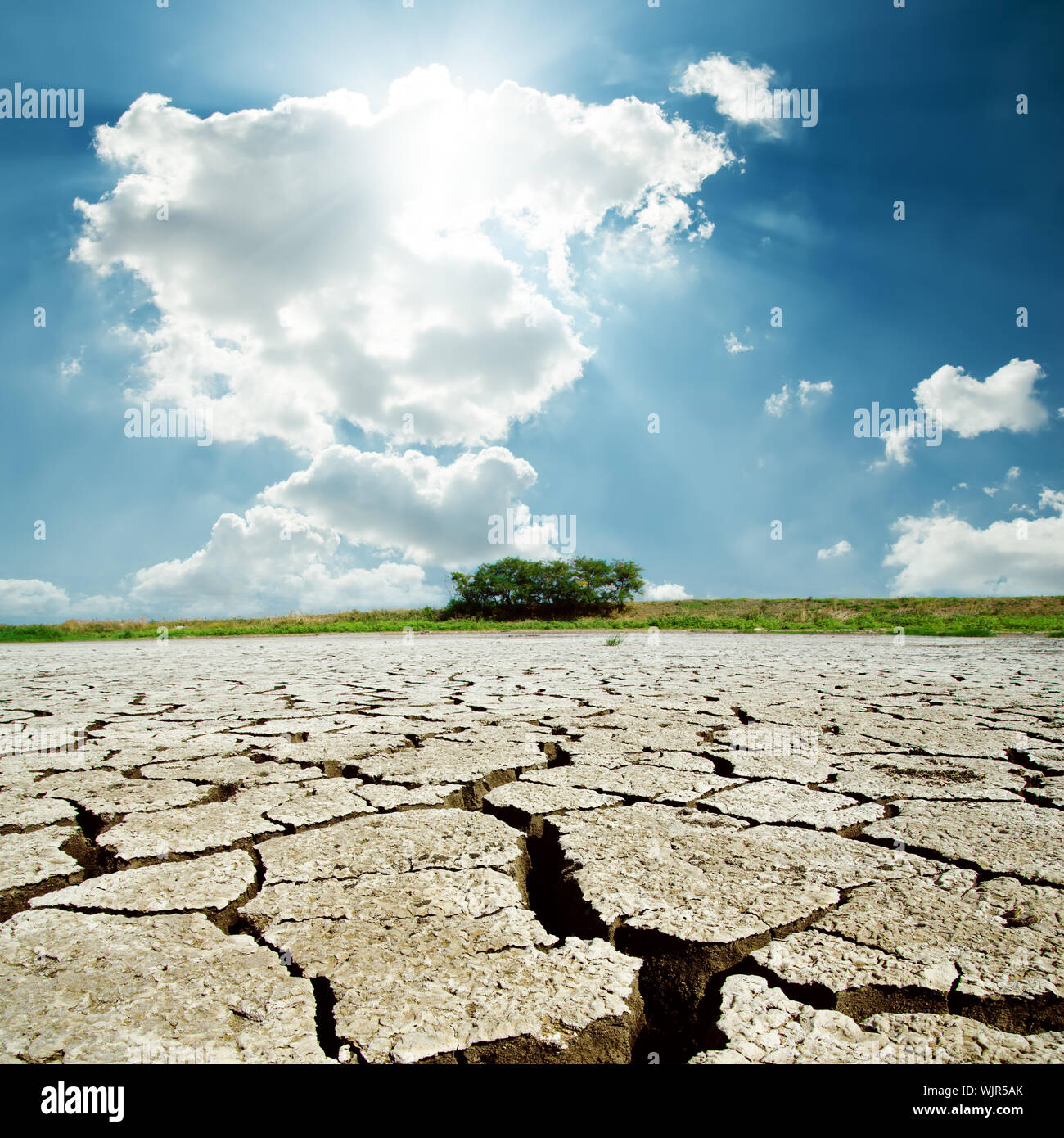 drought earth and sun in cloudy sky Stock Photo - Alamy