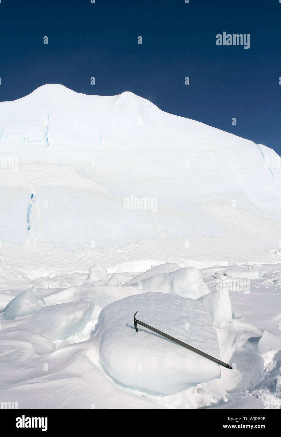 Ice axe stuck in an iceberg Stock Photo - Alamy