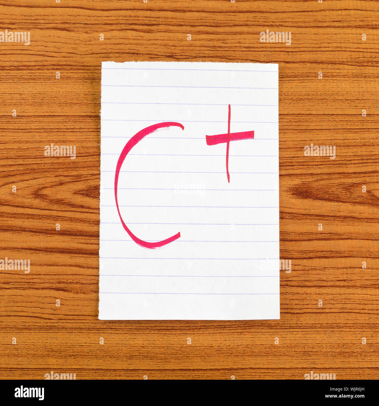 grade c plus on wood wall background Stock Photo - Alamy