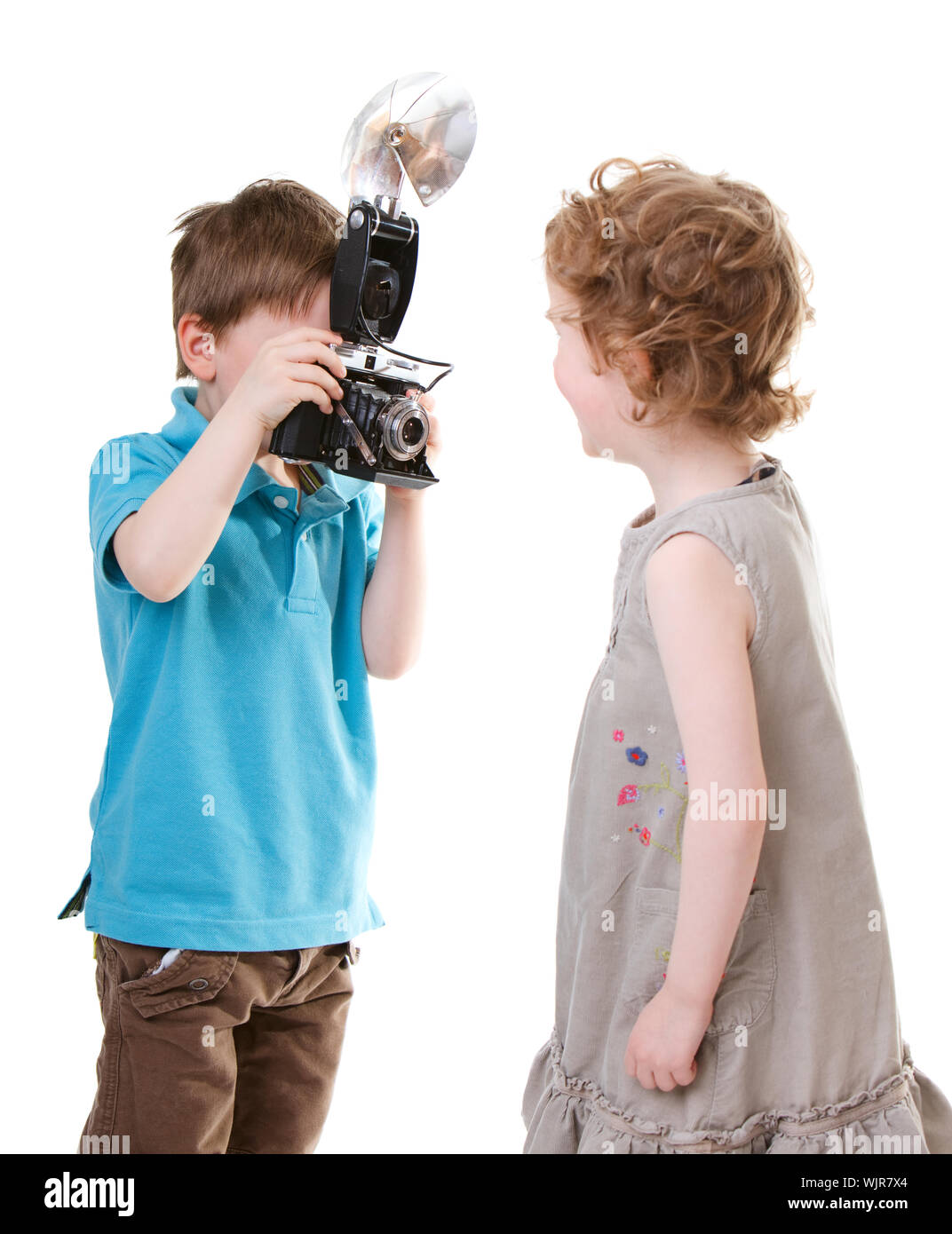 Young Photographer. Two small kids playing with antique camera Stock ...