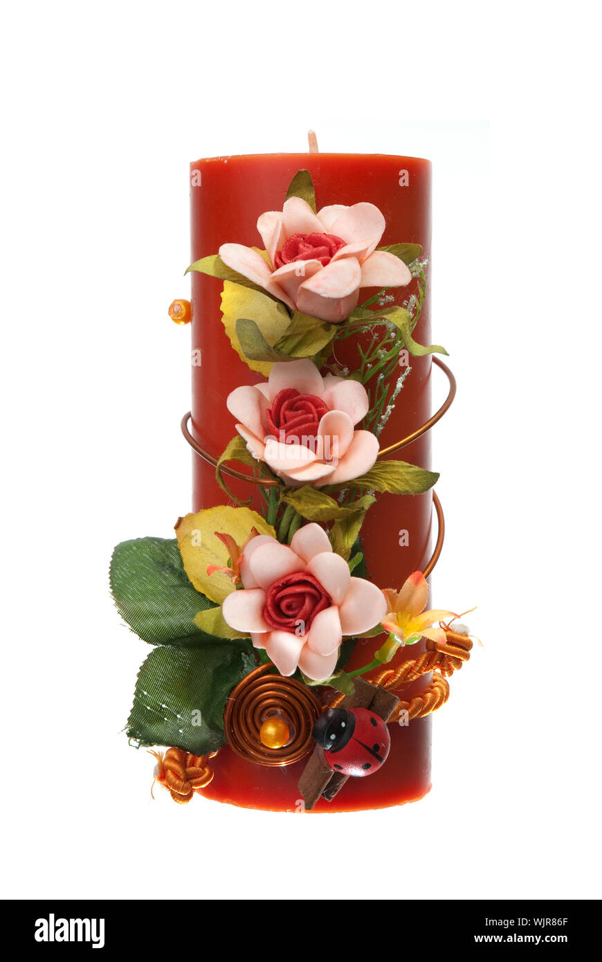 Large red candle with the flower decoration isolated on white ...