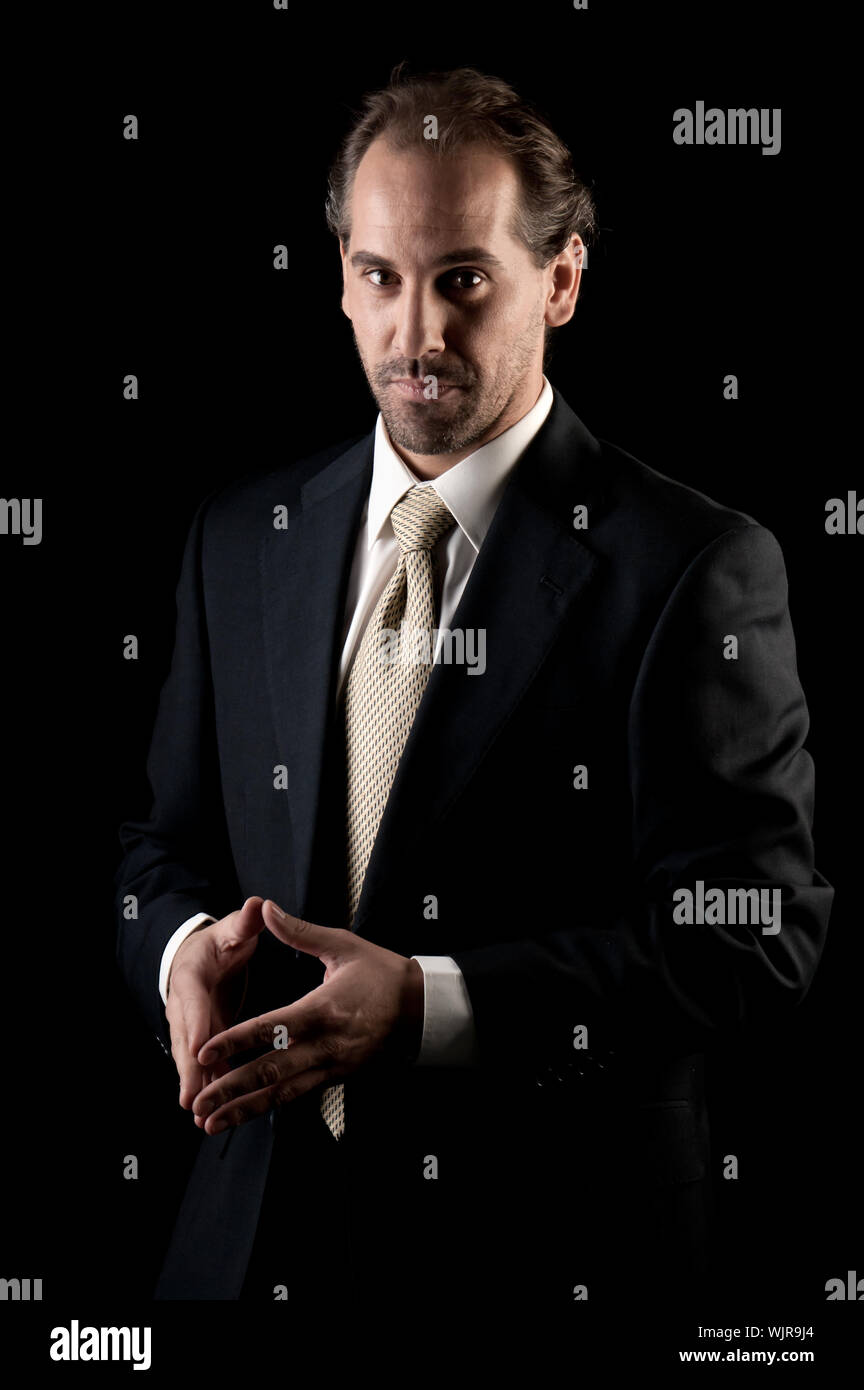 Adult businessman serious hands gesture on black background Stock Photo ...