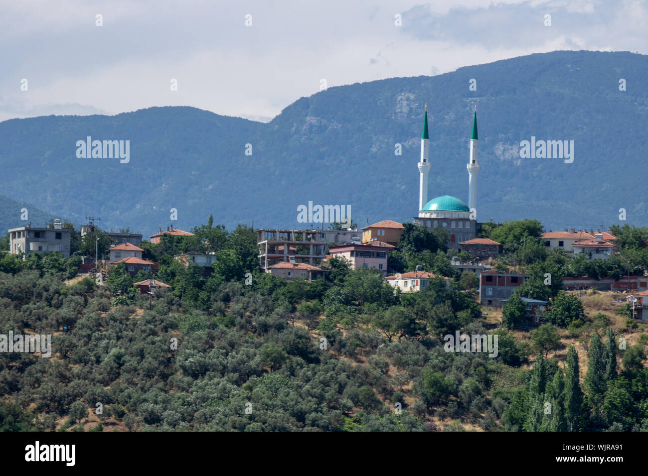 A muslim village on the hill in olive groves. Mountains in the ...