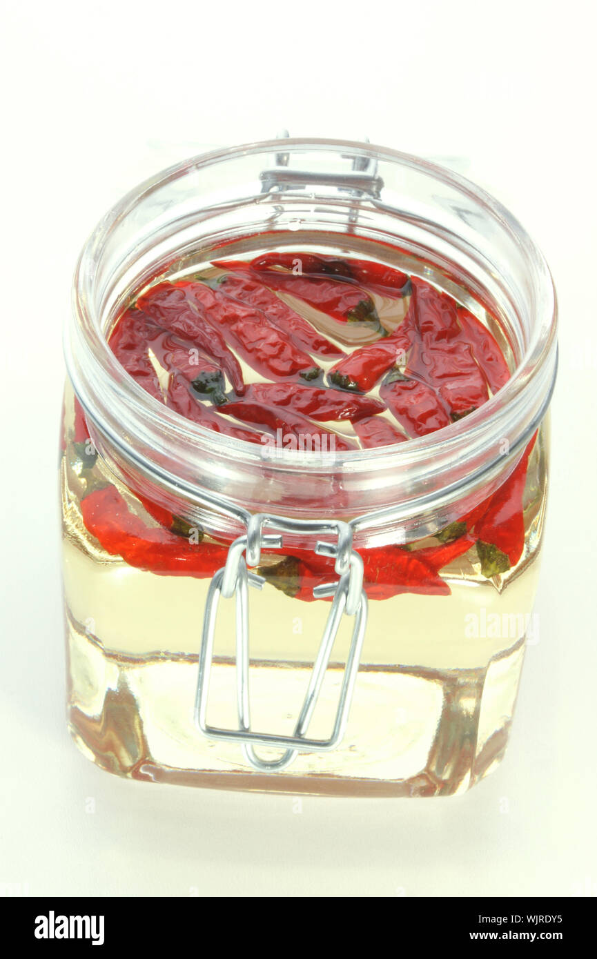 organic red chili in a jar with oil Stock Photo - Alamy