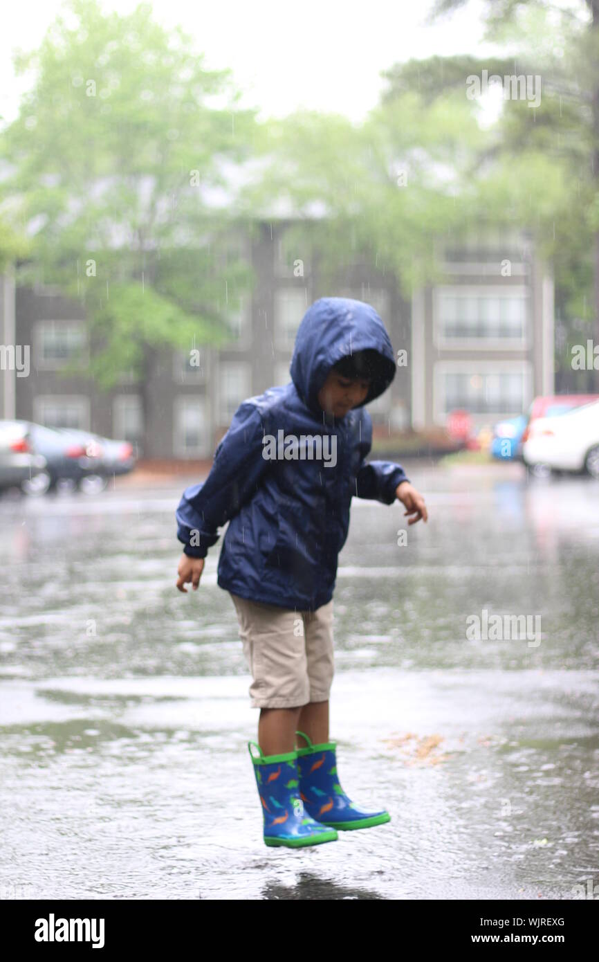 Jumping over puddle hi-res stock photography and images - Alamy