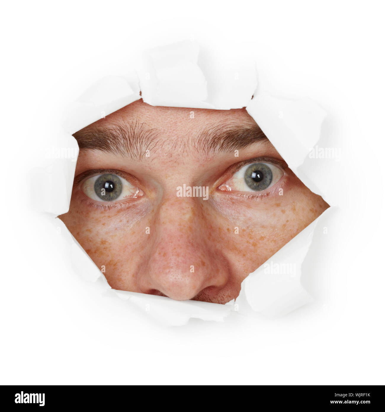 The scared person hiding in a hole Stock Photo - Alamy