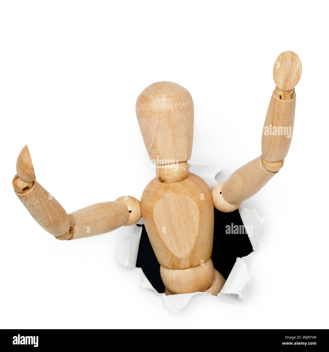 Wooden toy man looks out of the hole isolated on white background Stock ...