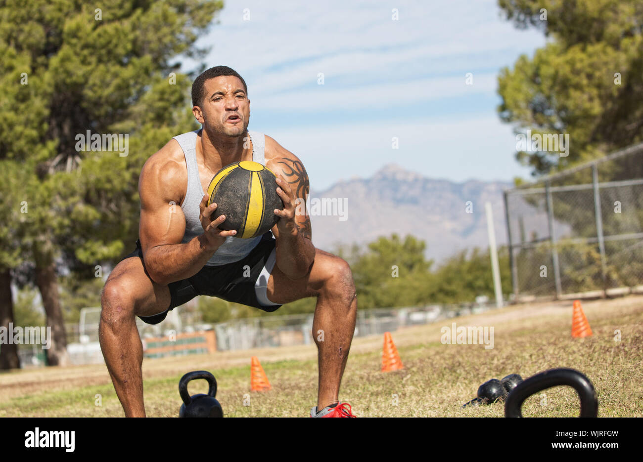 Strong african man squatting hi-res stock photography and images - Alamy