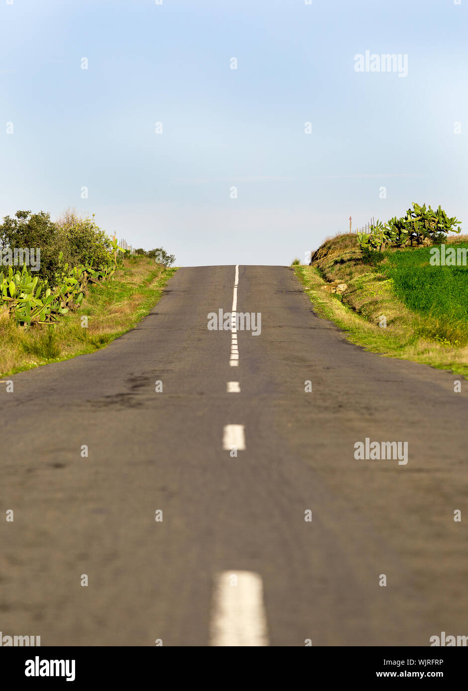 Long Country Road with Markings on Blue Sky Background Stock Photo - Alamy