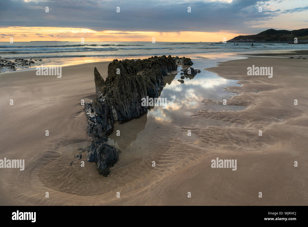 Rock formation at Combesgate Beach in north Devon surrounded by water ...