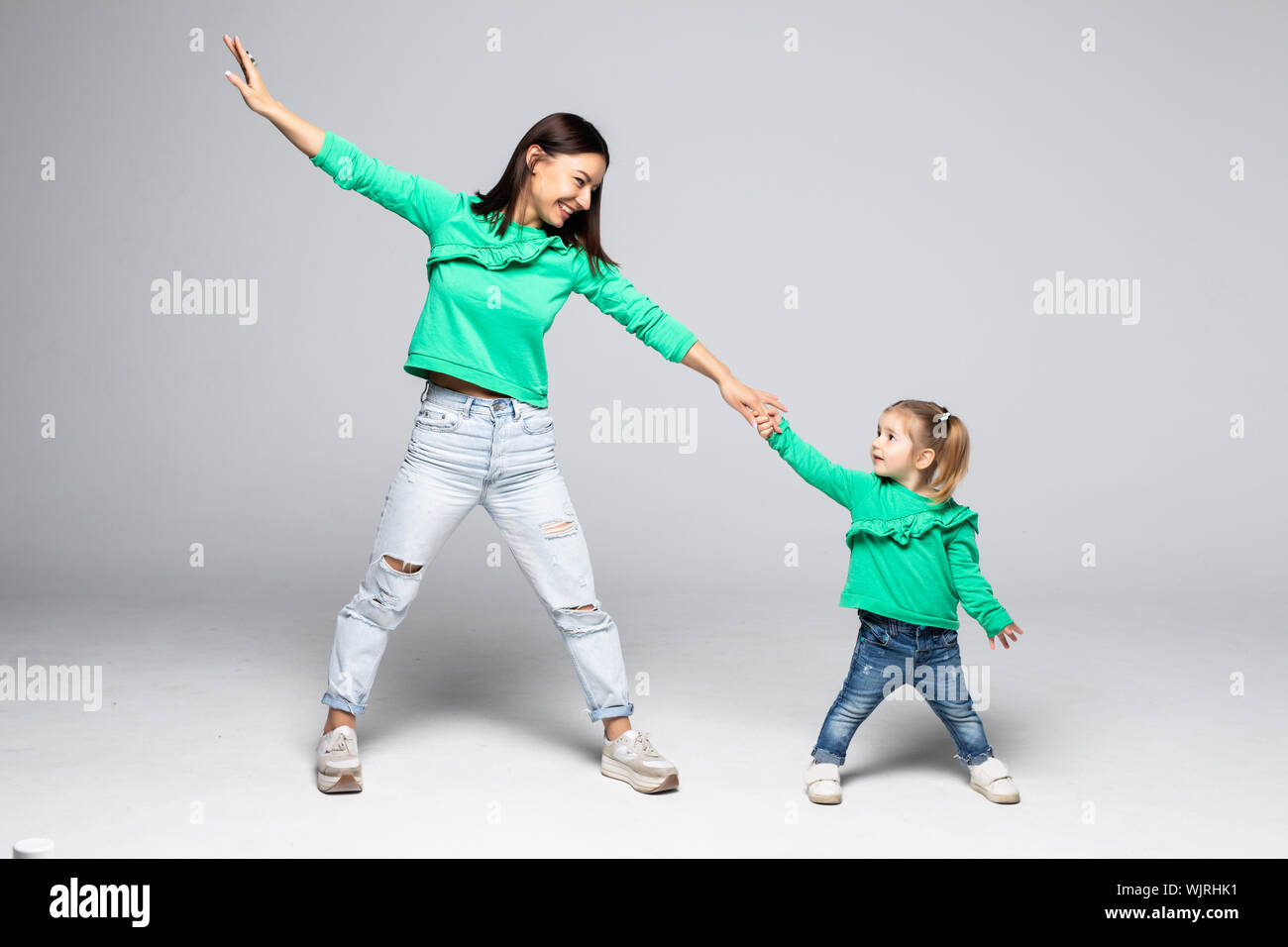 pretty mother standing with her cute daughter Stock Photo - Alamy