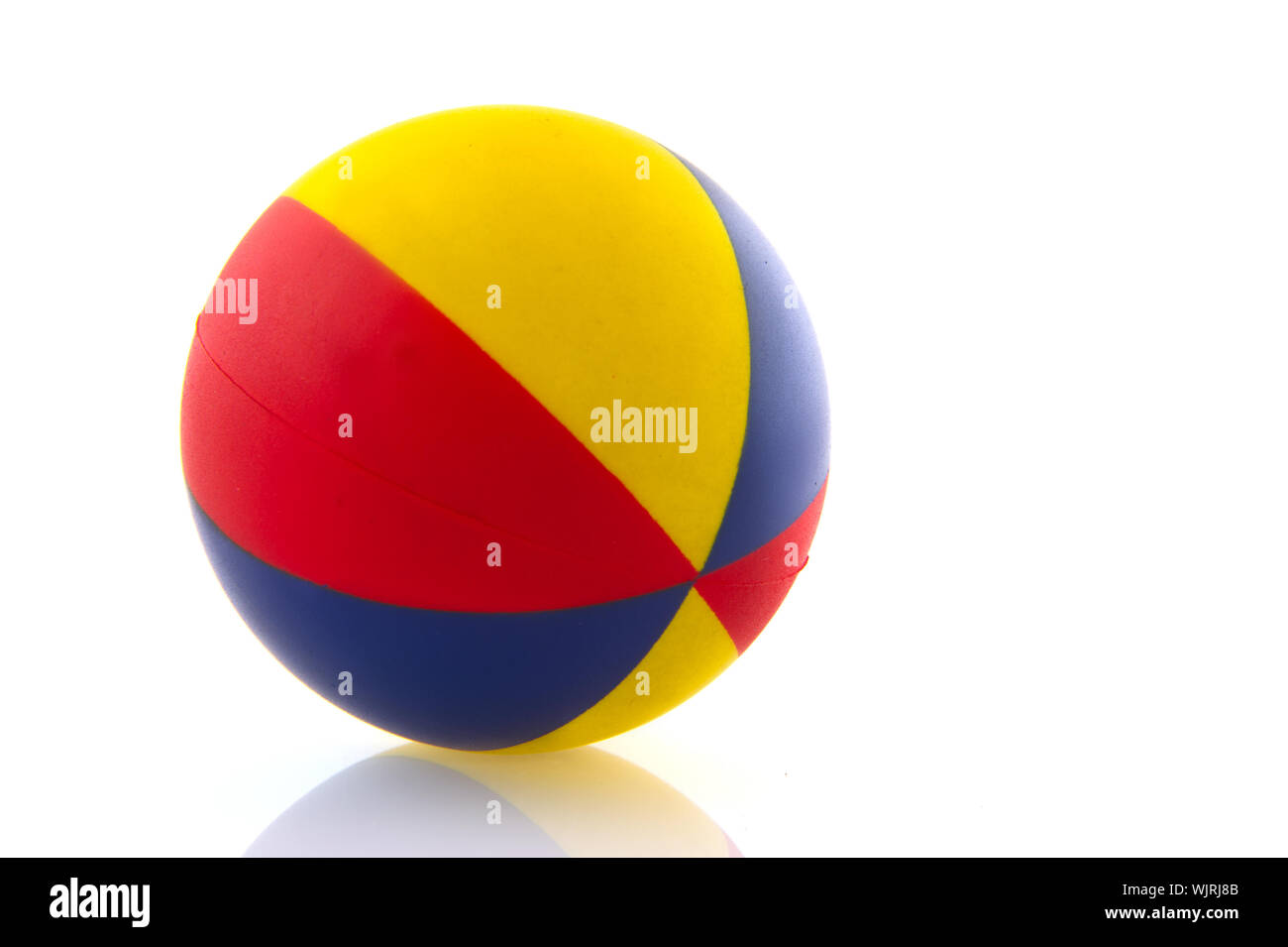 colorful toy ball in red blue and yellow isolated over white Stock ...