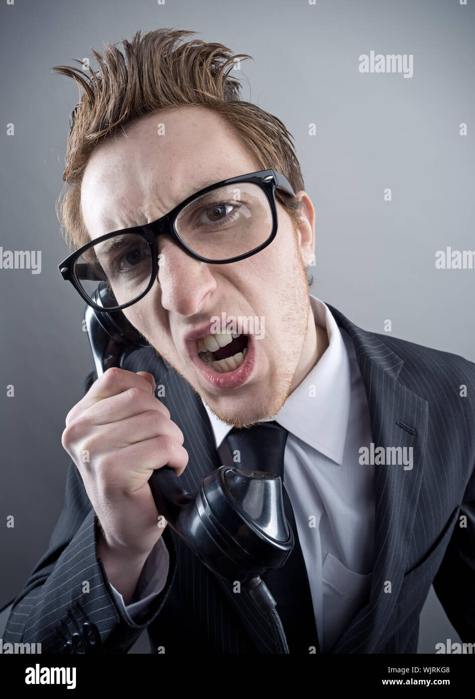 Angry nerd businessman retro telephone call shouting Stock Photo - Alamy