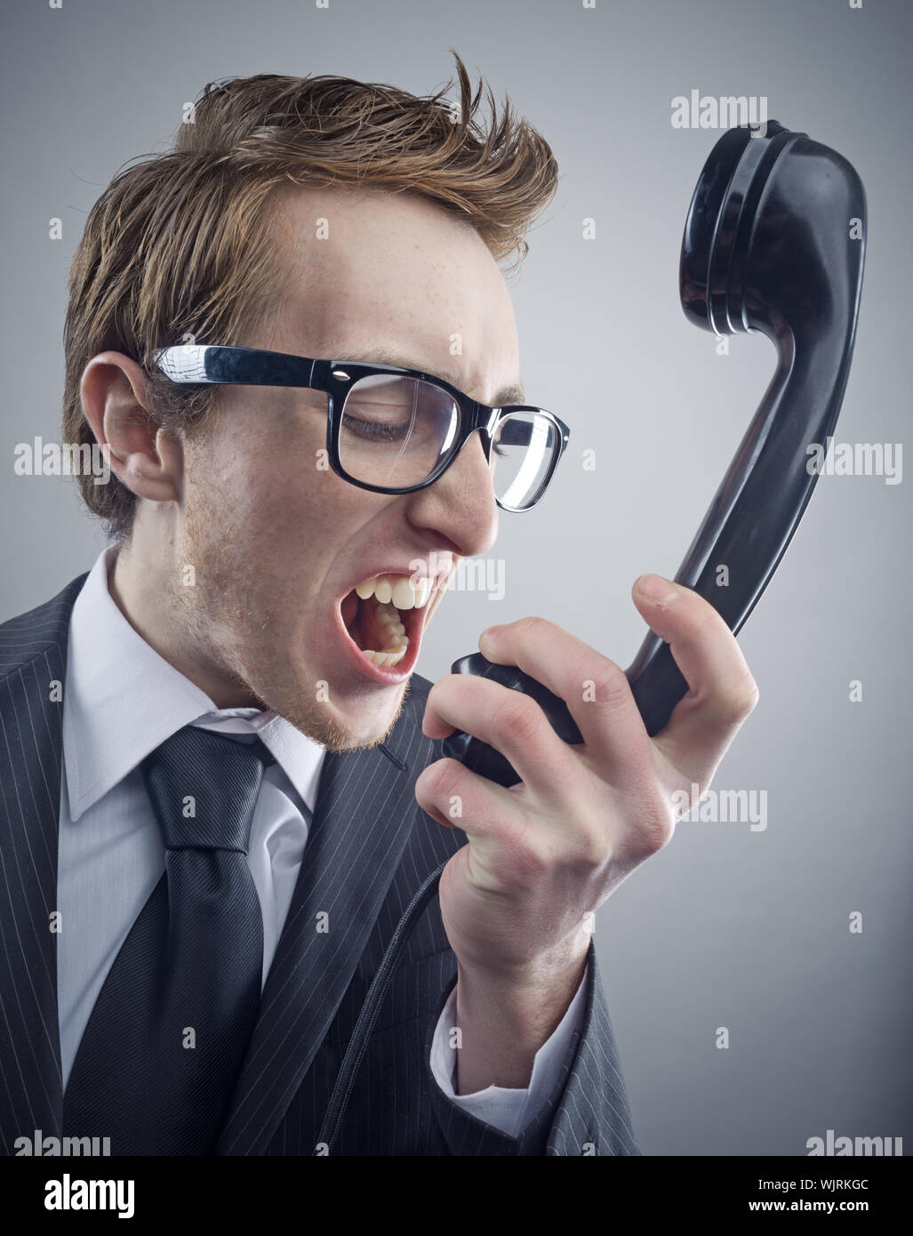 Angry nerd businessman retro telephone call shouting Stock Photo - Alamy
