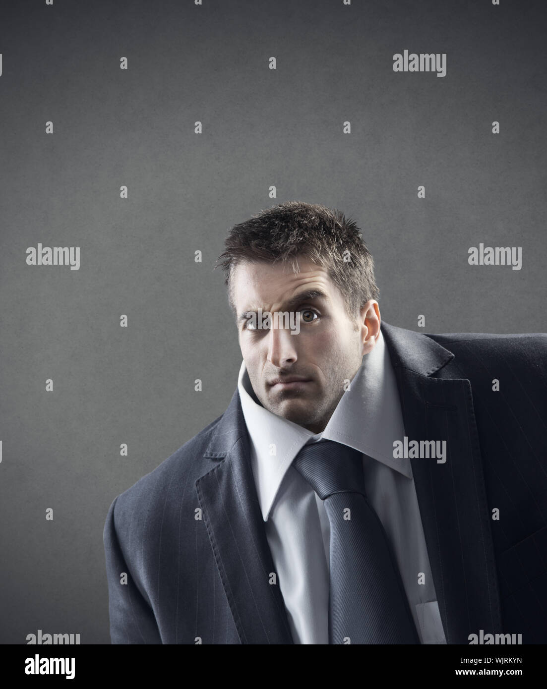 Young businessman with raised eyebrow and doubtful expression Stock ...