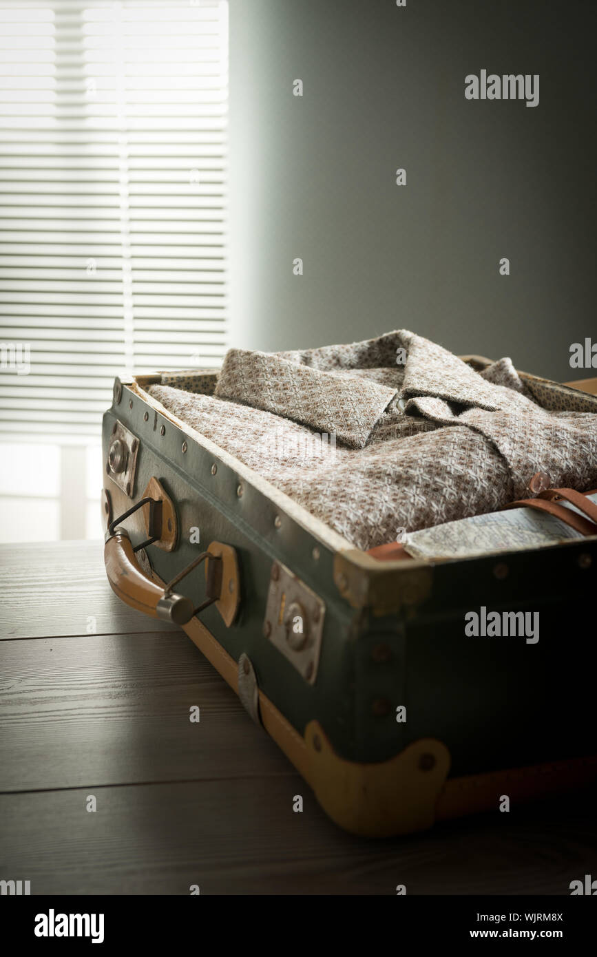 Open vintage suitcase with old fashioned clothes inside Stock Photo - Alamy