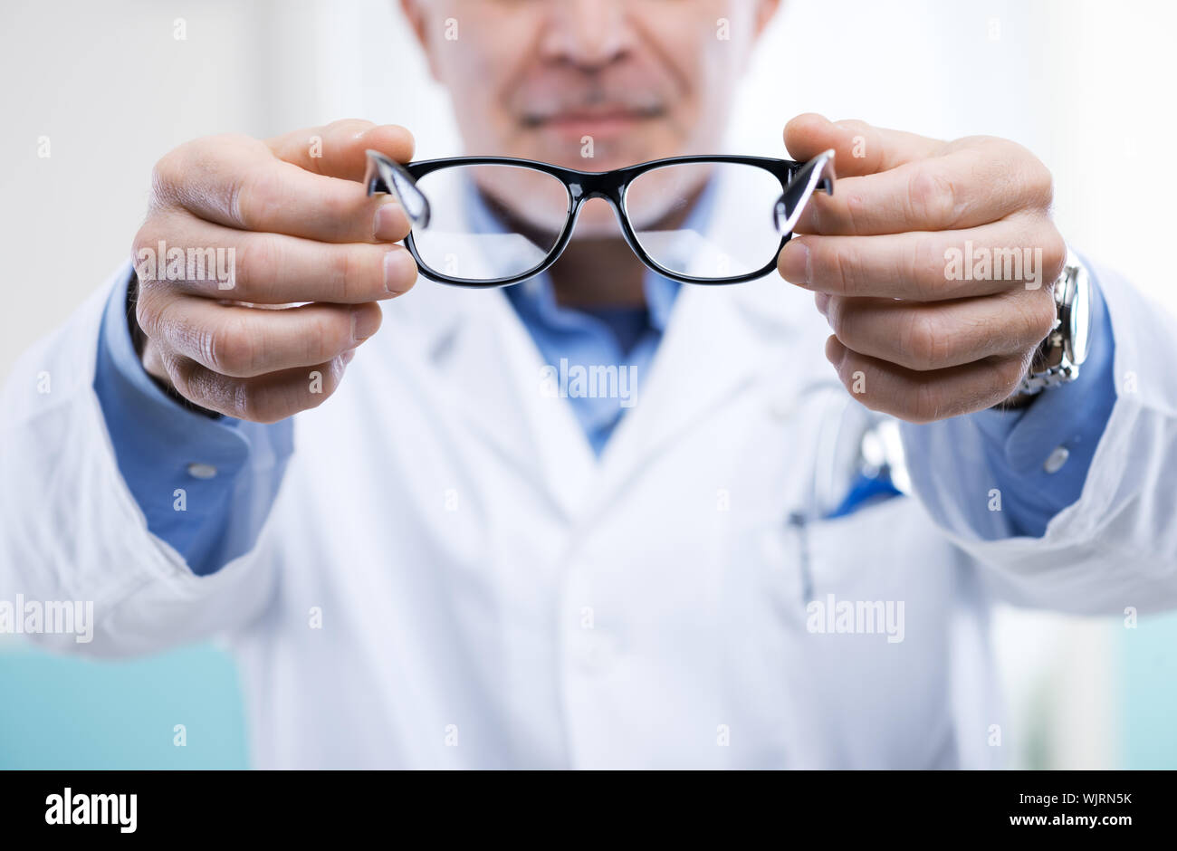 Oculist giving a pair of glasses during a visit Stock Photo - Alamy
