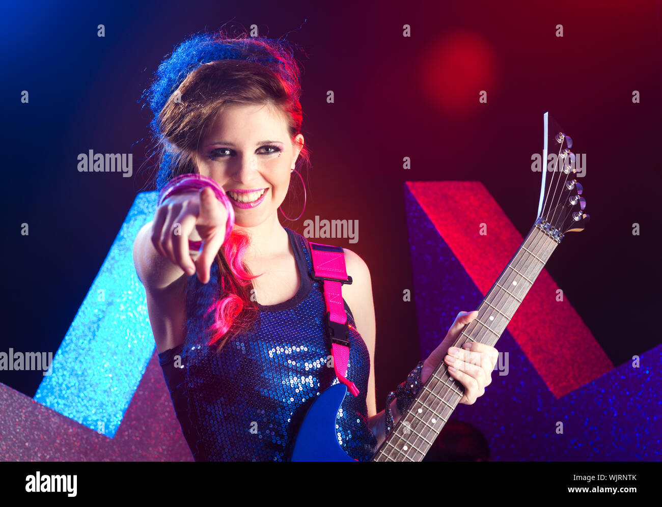 Young attractive pop star girl pointing at camera and smiling Stock ...