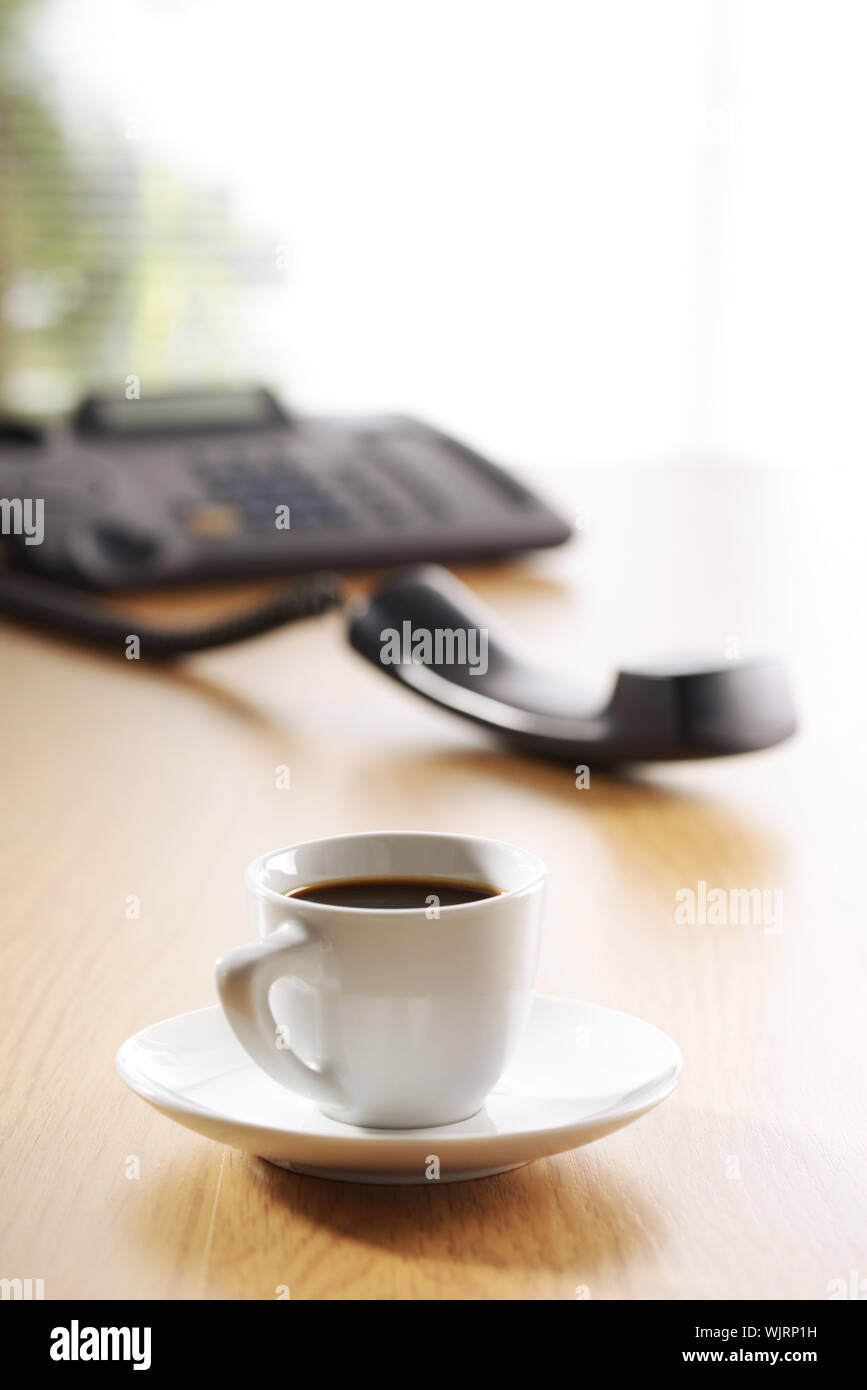 Business Office scene, cup of coffee and telephone on desk Stock Photo ...