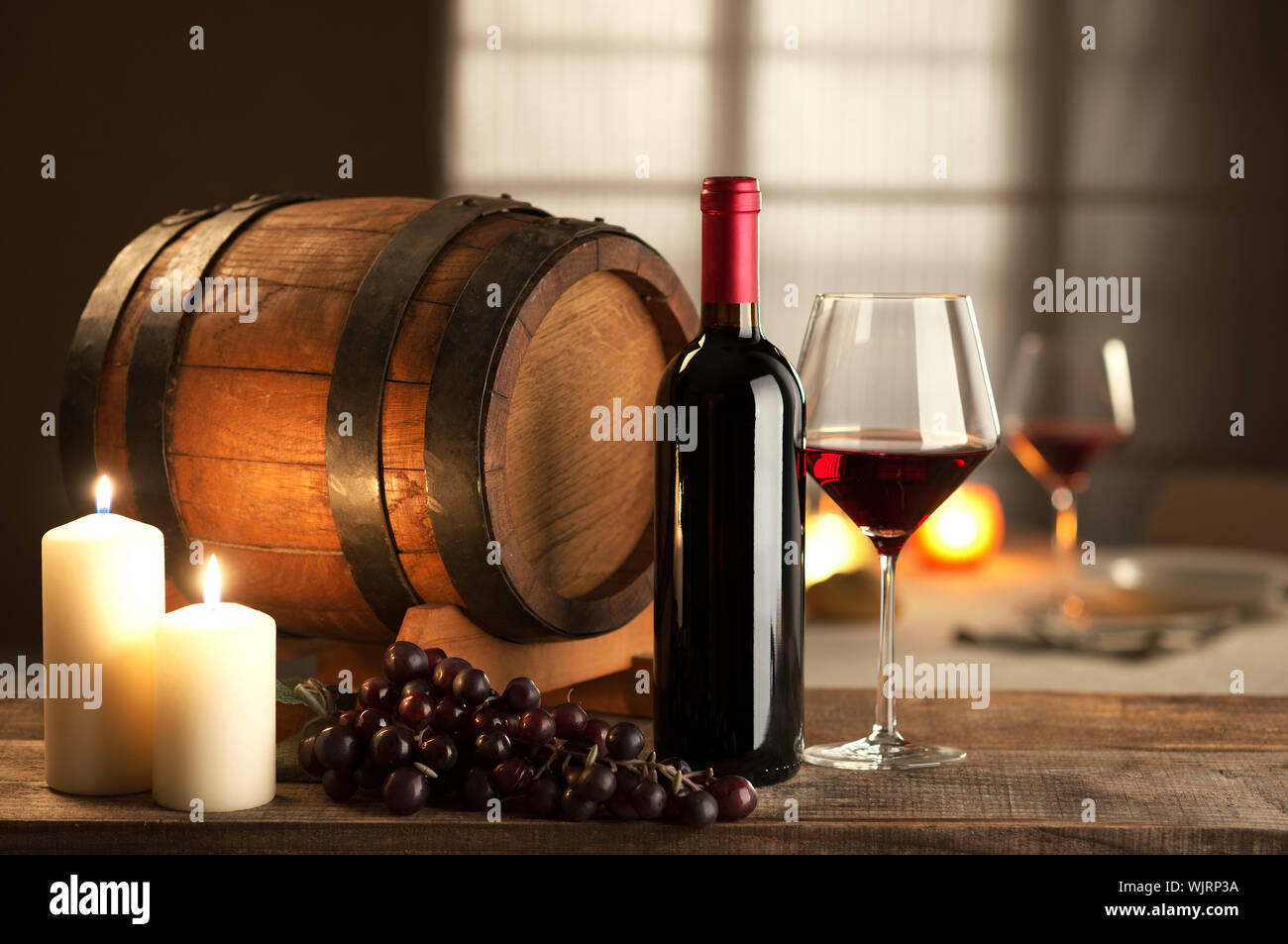 Bottle, glass, grape and barrel still life with restaurant on ...