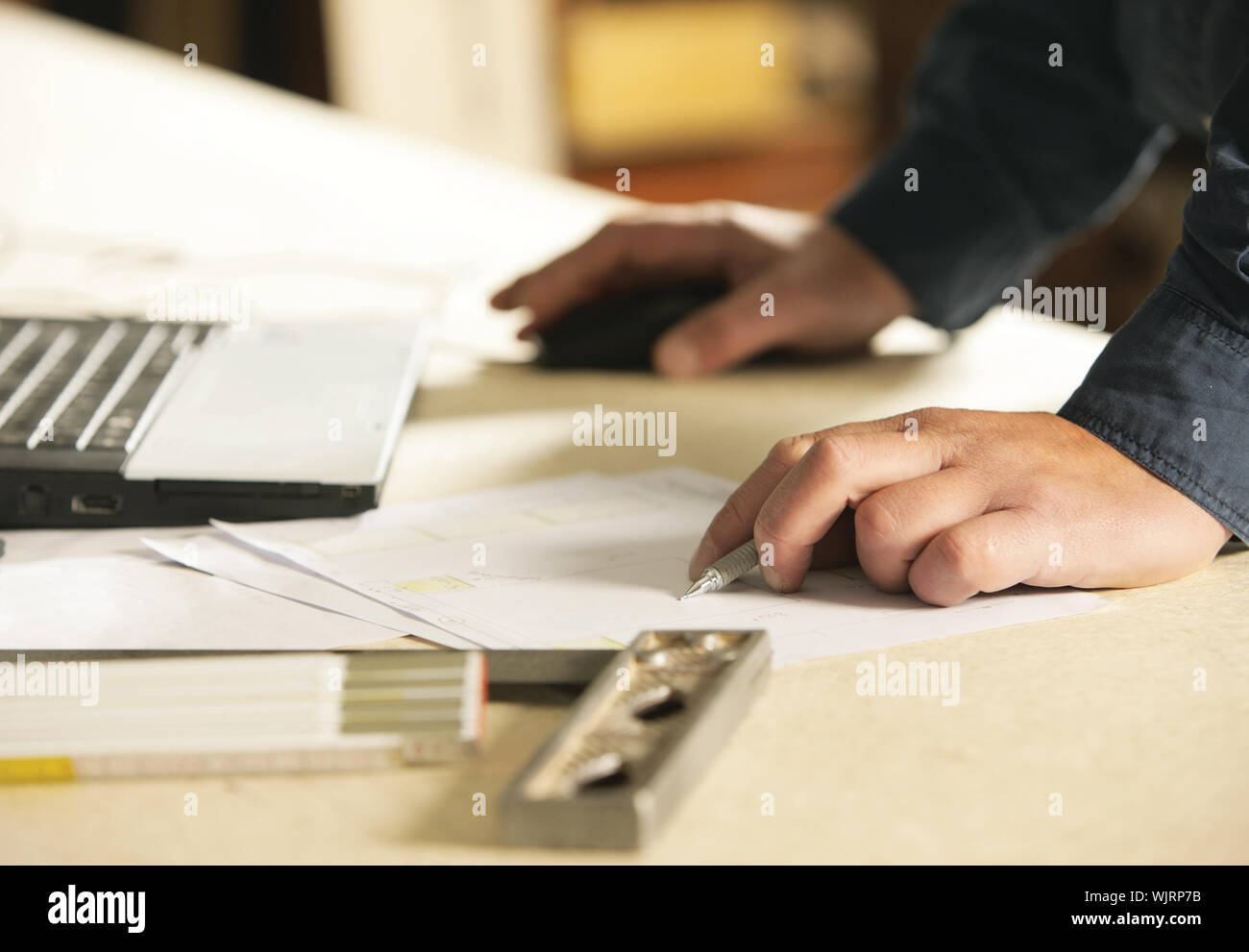 Designer at work with laptop, ruler and paperwork Stock Photo - Alamy