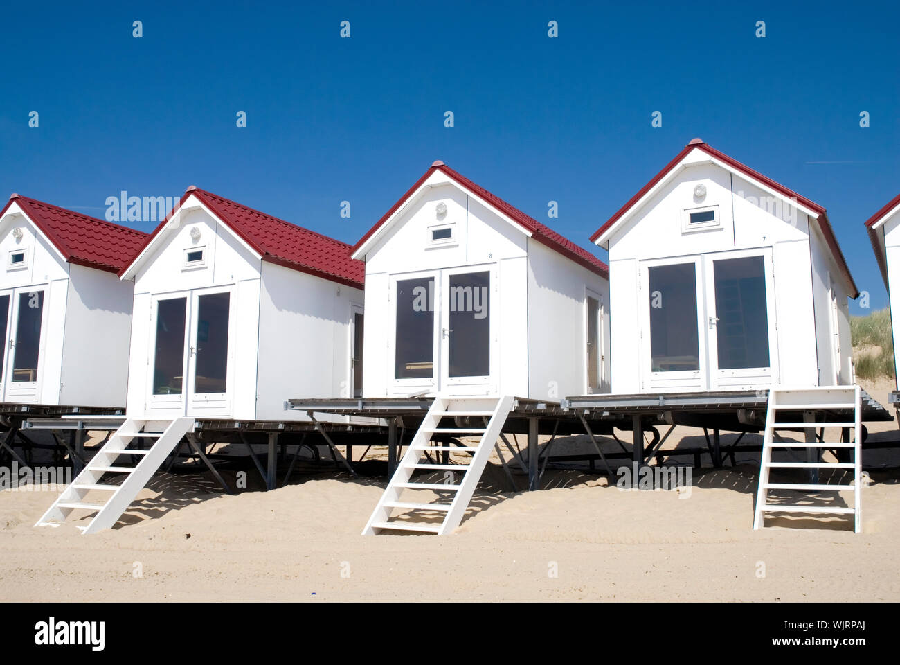 row of white beach-houses Stock Photo - Alamy