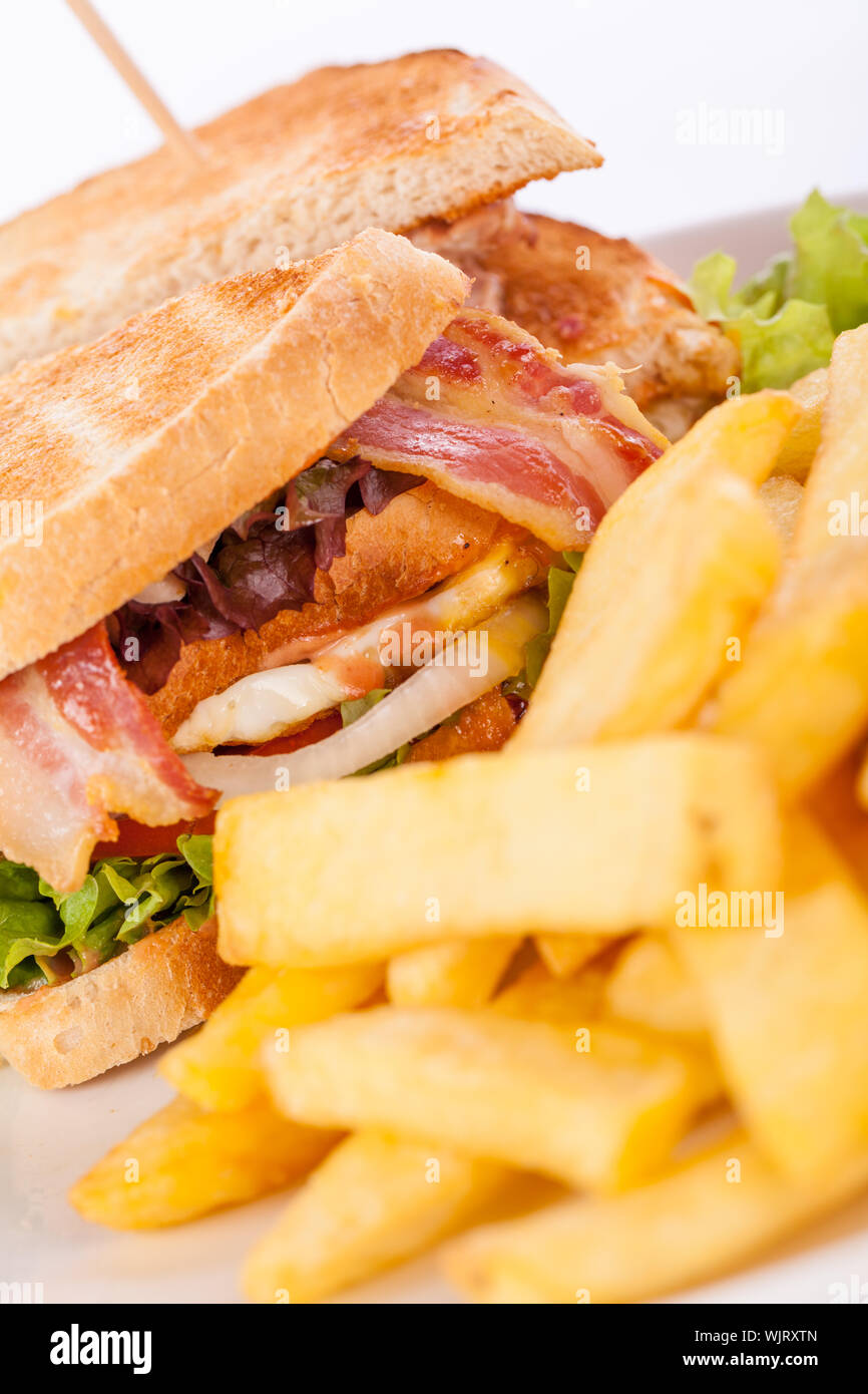 Club sandwich on toasted white bread with a meat filling served with ...