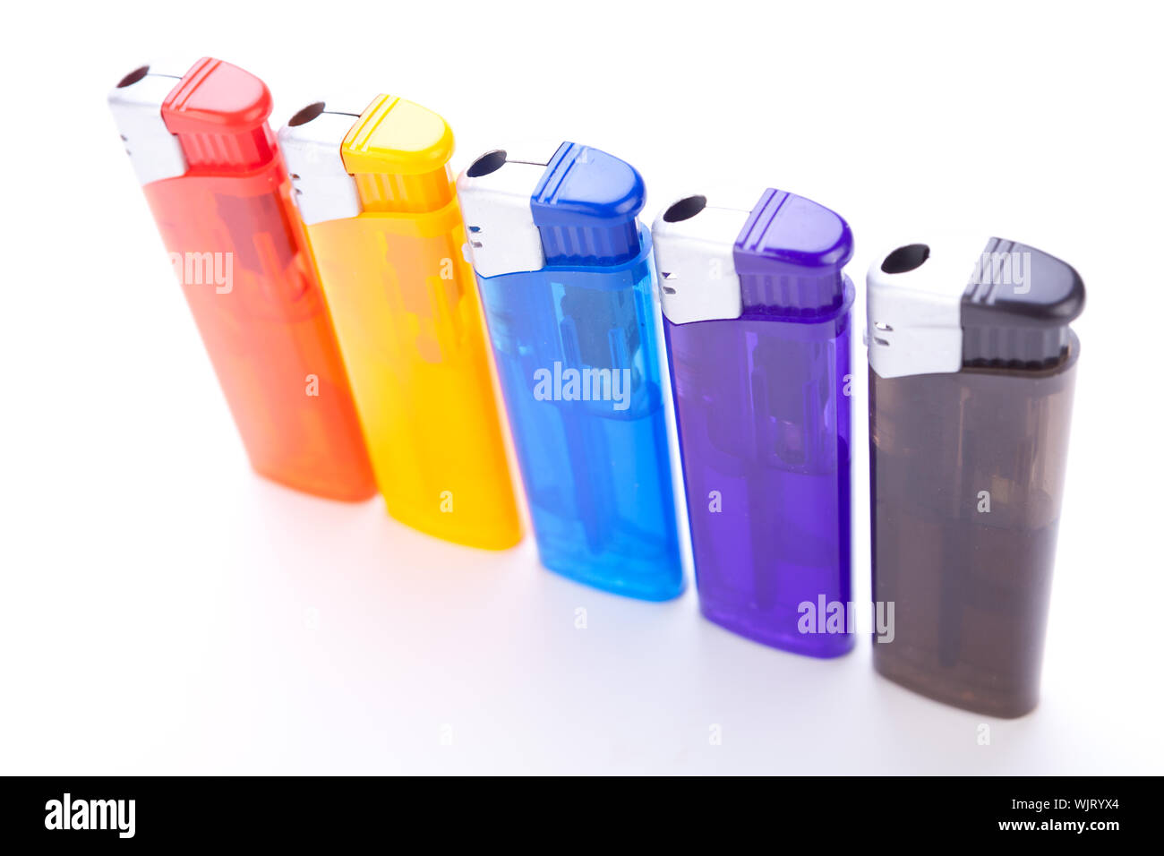 Row of vividly coloured plastic disposable lighters for smokers in red ...
