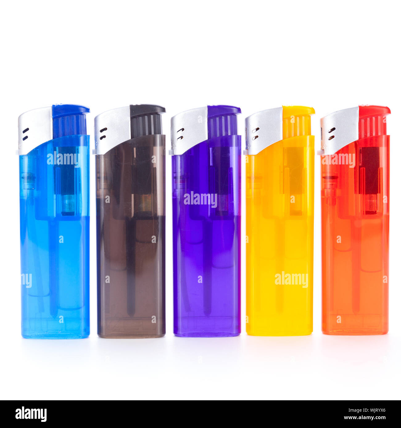 Row of vividly coloured plastic disposable lighters for smokers in red ...