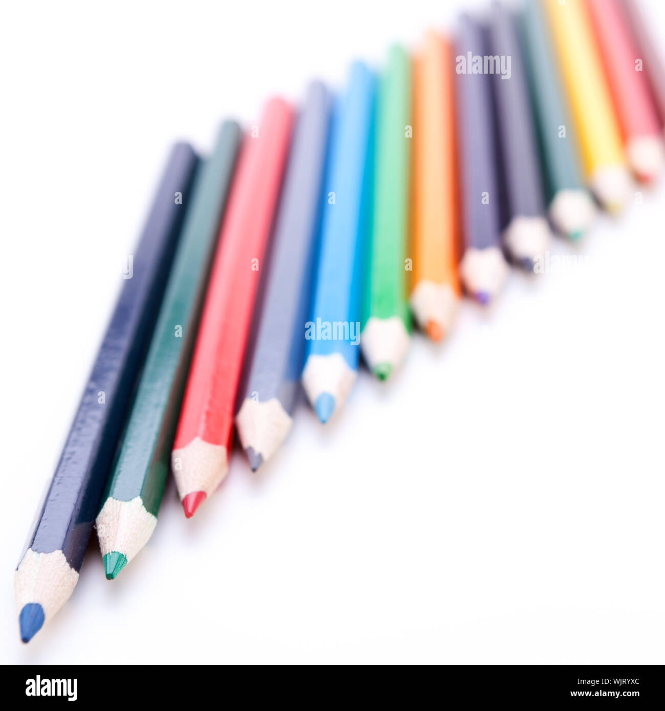 Bunch of sharpened wooden colourful pencil crayons in the colours of ...