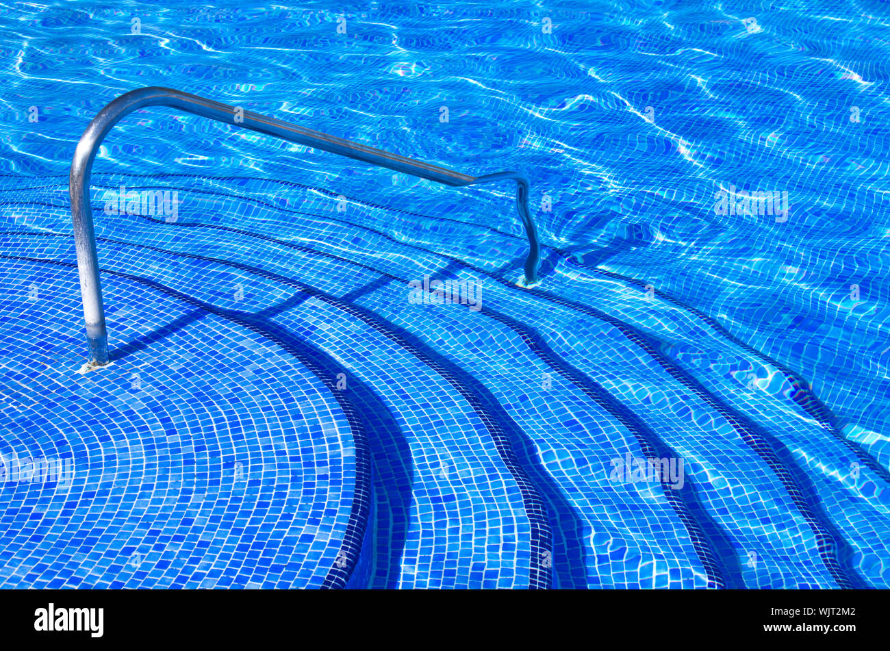 Blue pool water with sun reflections Stock Photo - Alamy