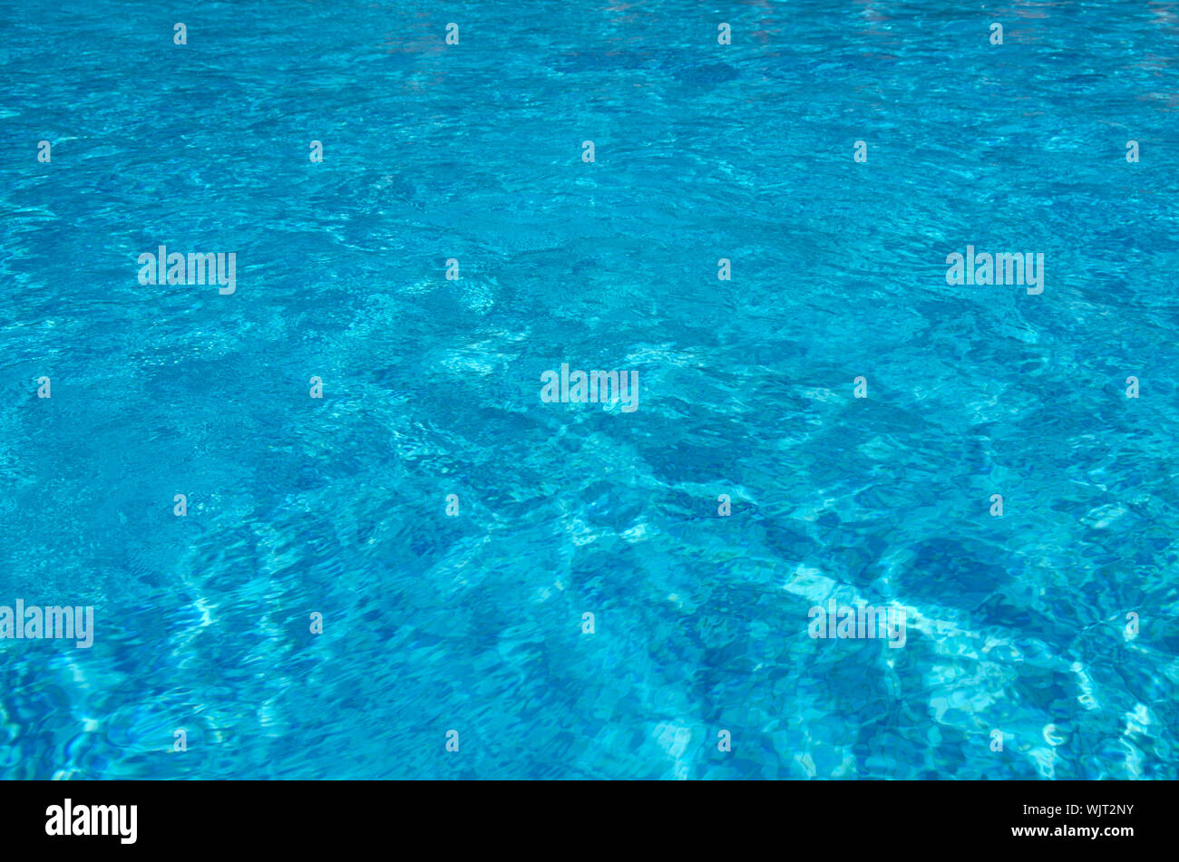 Blue pool water with sun reflections Stock Photo - Alamy