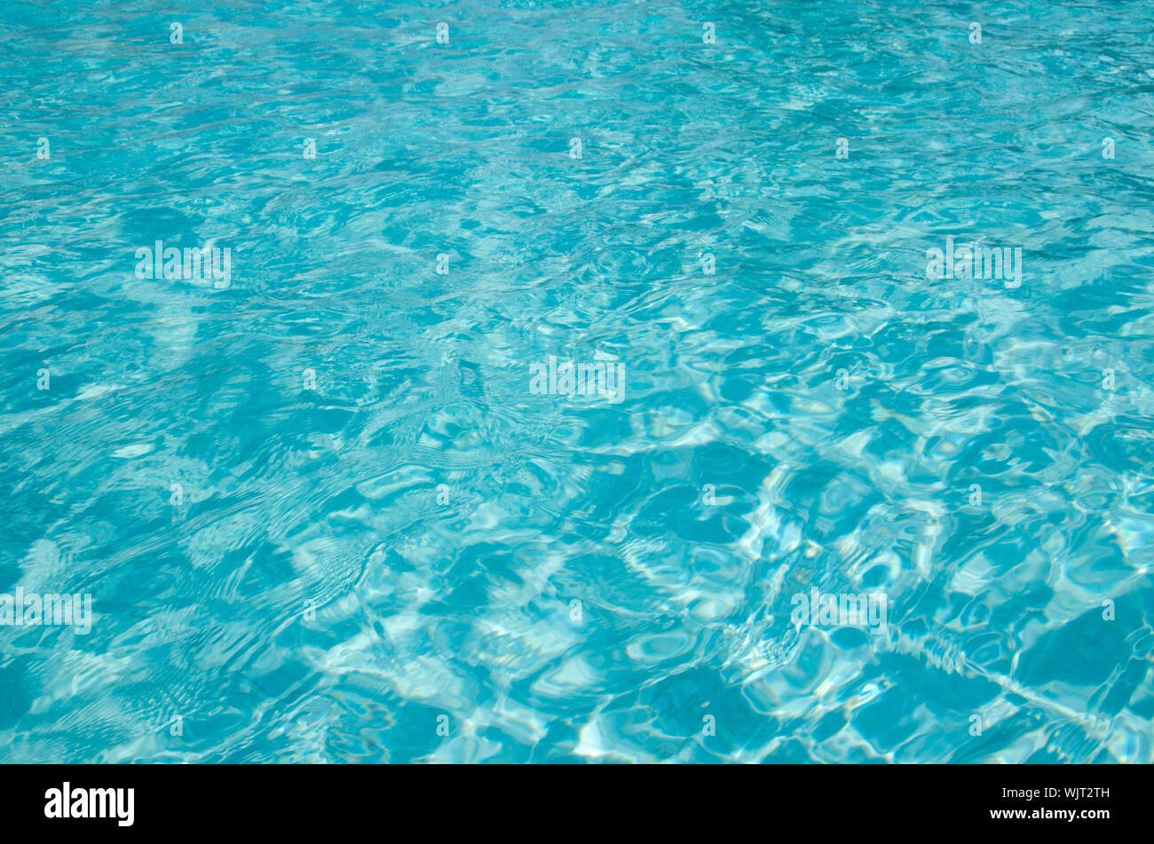 Blue pool water with sun reflections Stock Photo - Alamy