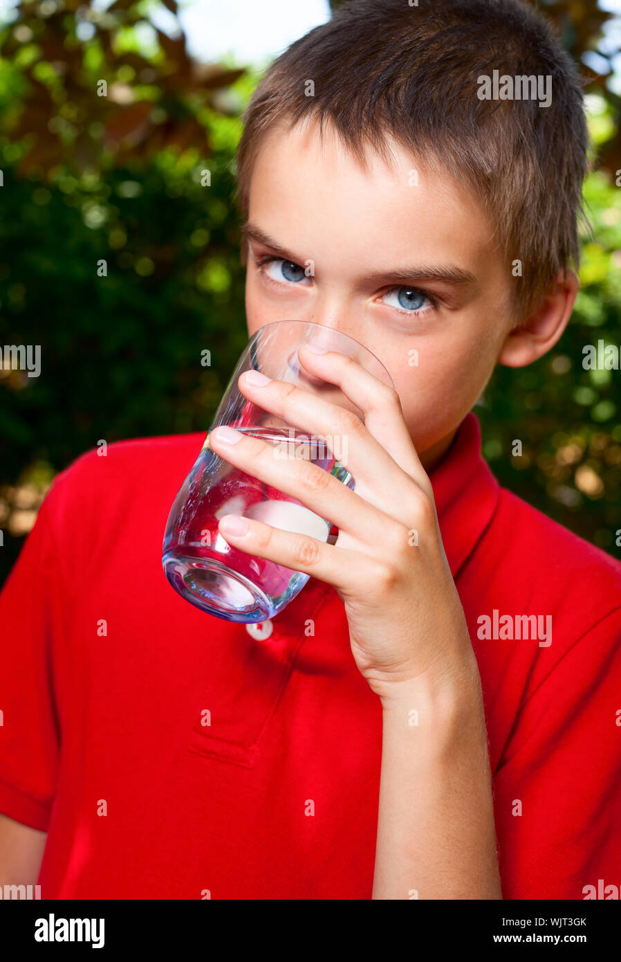 Cute boy drinking water outdoors Stock Photo - Alamy