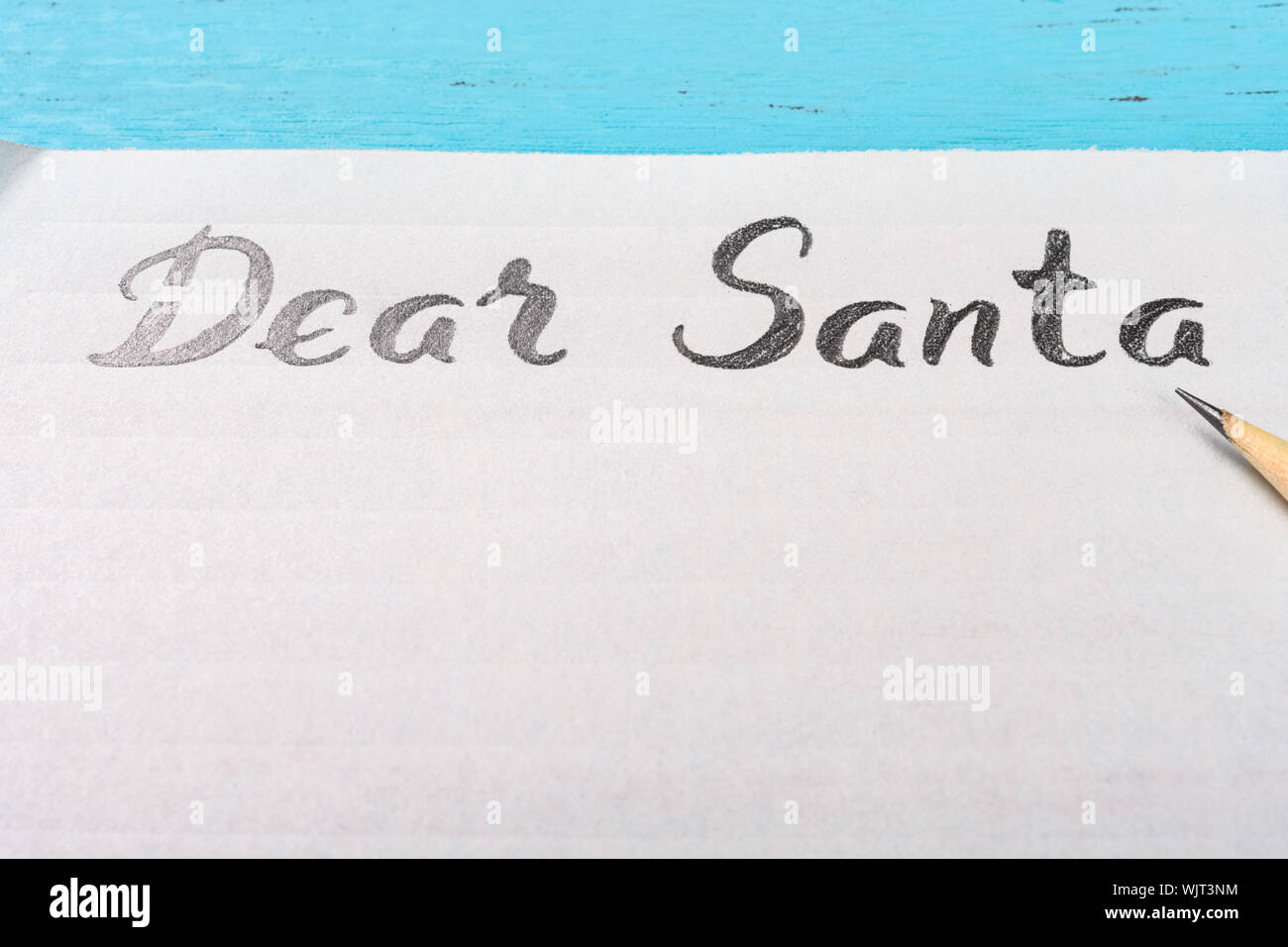 letter paper with hand written Dear Santa and a pencil on table Stock ...