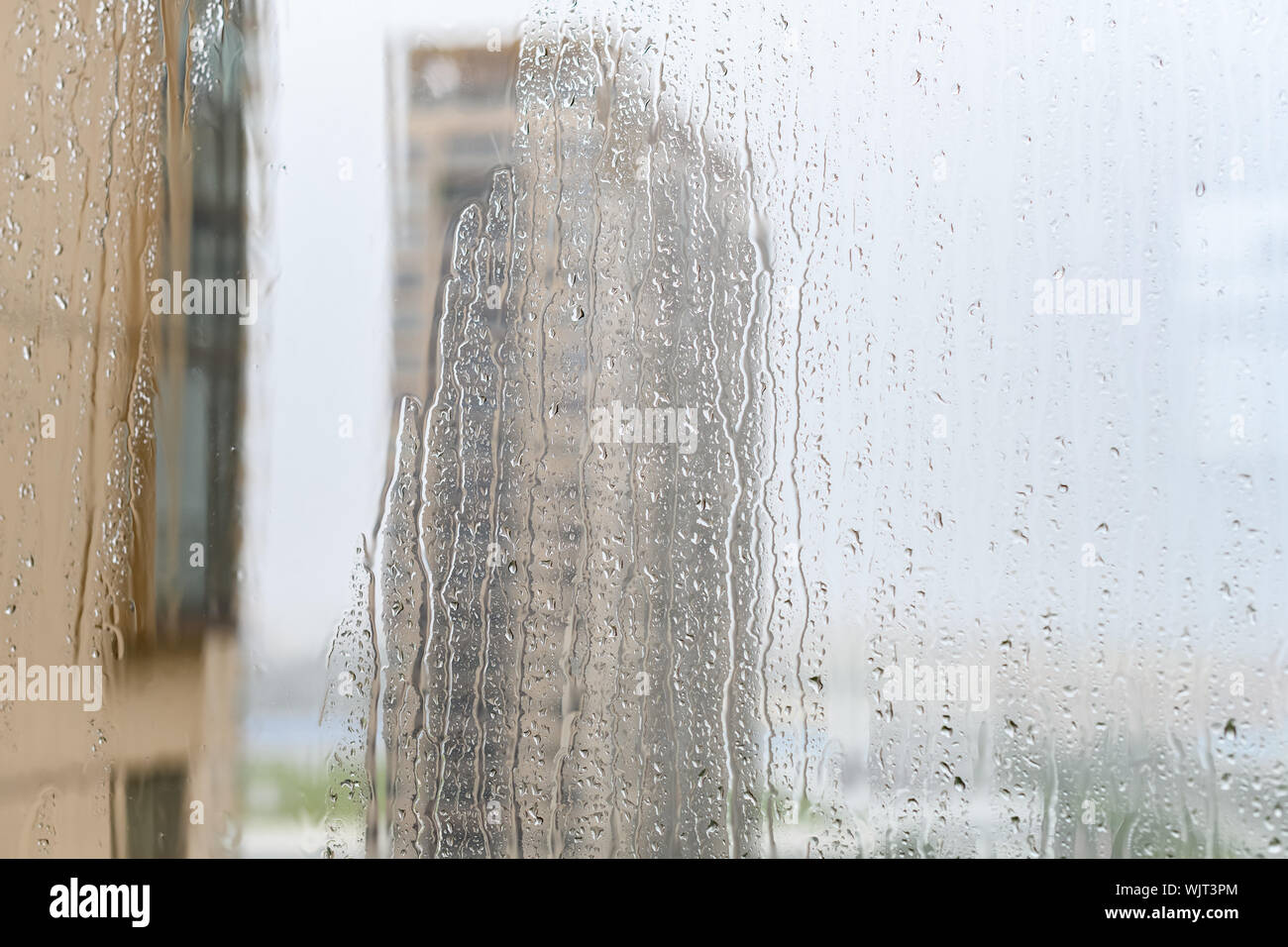 window with raindrops and blur buildings at background Stock Photo - Alamy