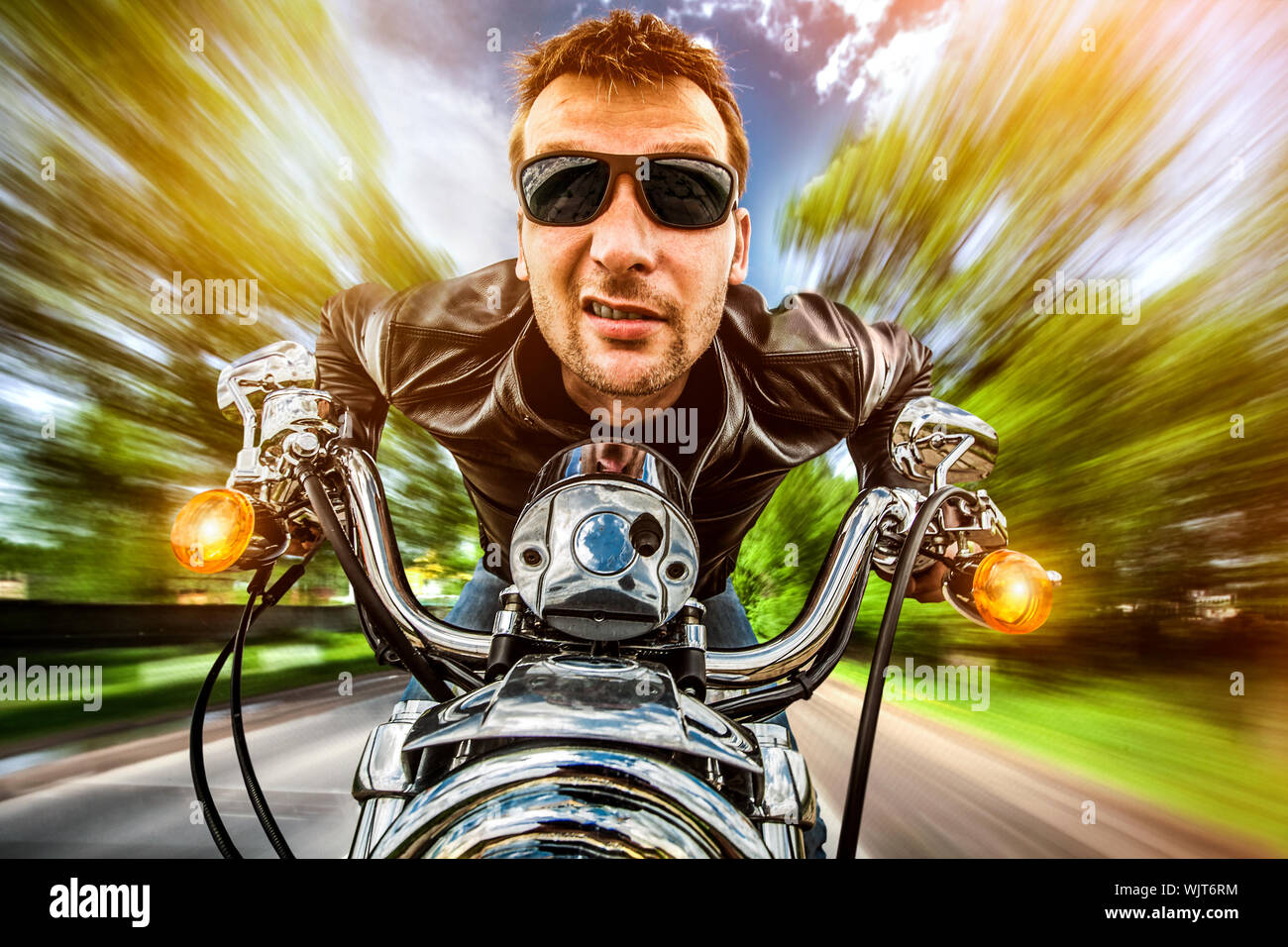 Biker man wearing a leather jacket and sunglasses sitting on his ...
