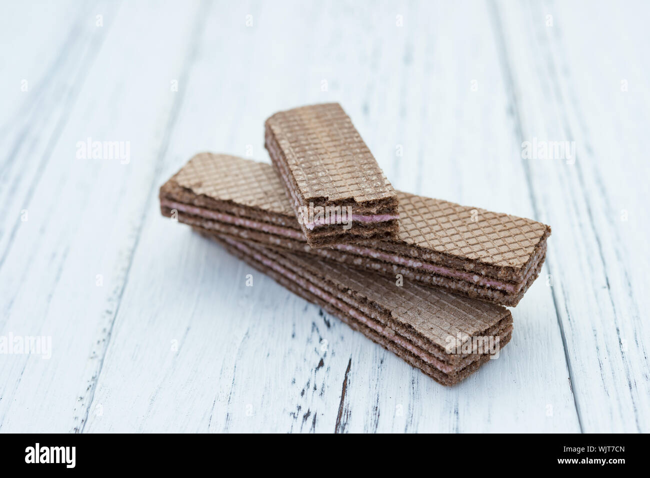 strawberry flavor wafer blocks on a white wood background Stock Photo ...
