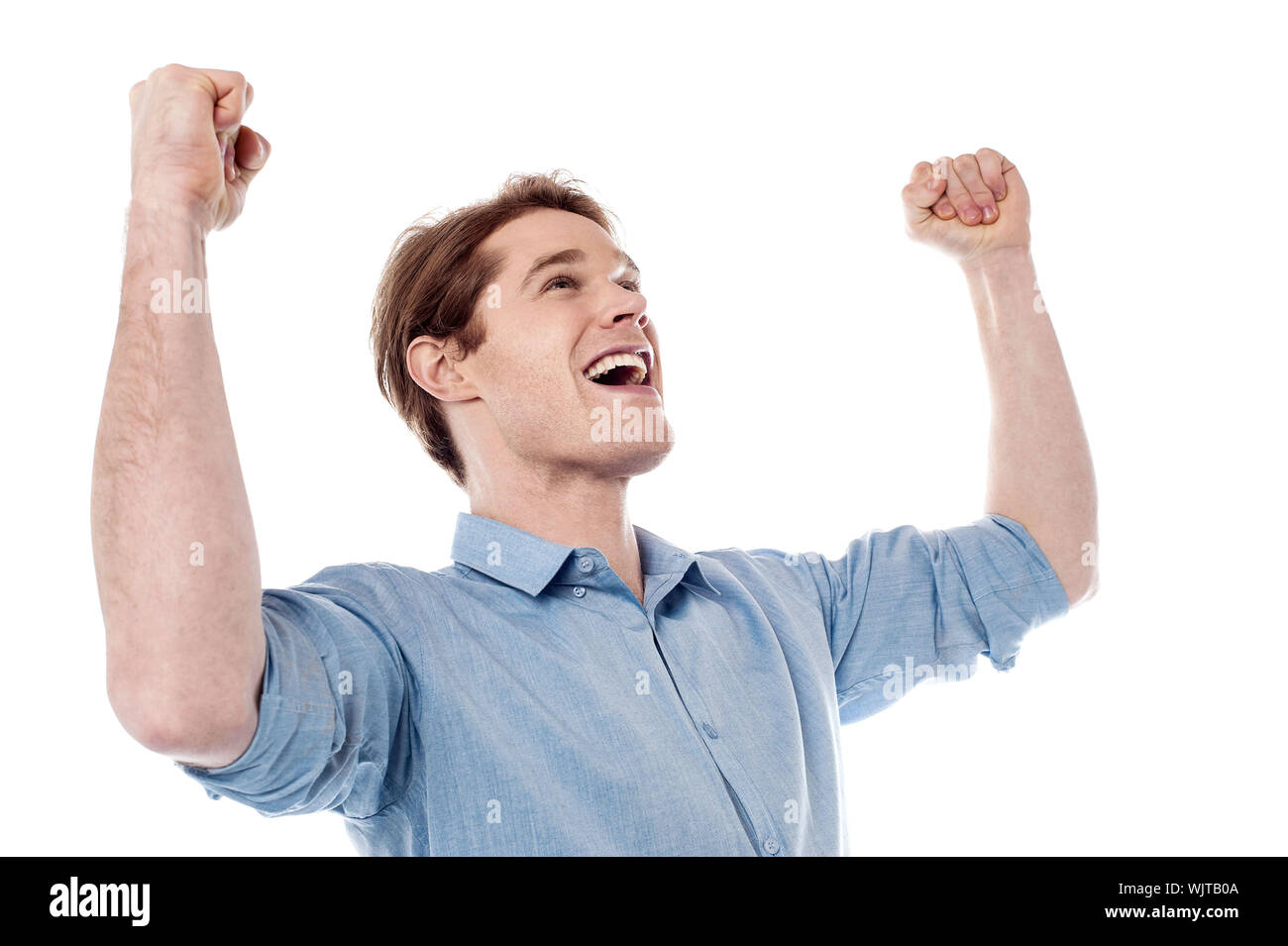Confident young man celebrating his success Stock Photo - Alamy