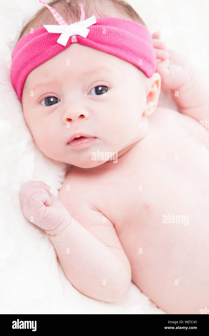 happy newborn baby girl just a week old photographed in the studio ...