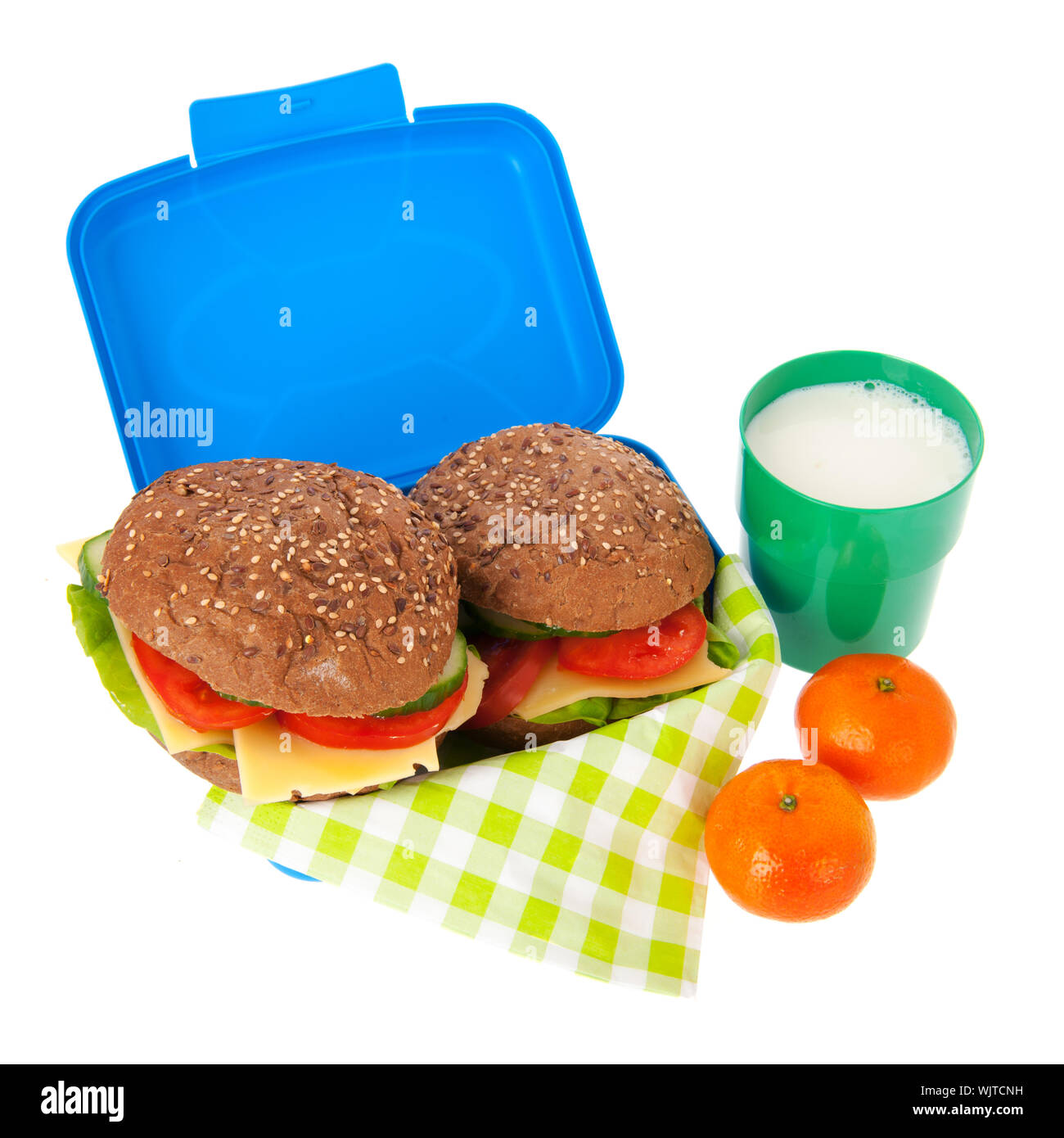 Healthy brown bread rolls in blue lunch box with fruit and milk ...