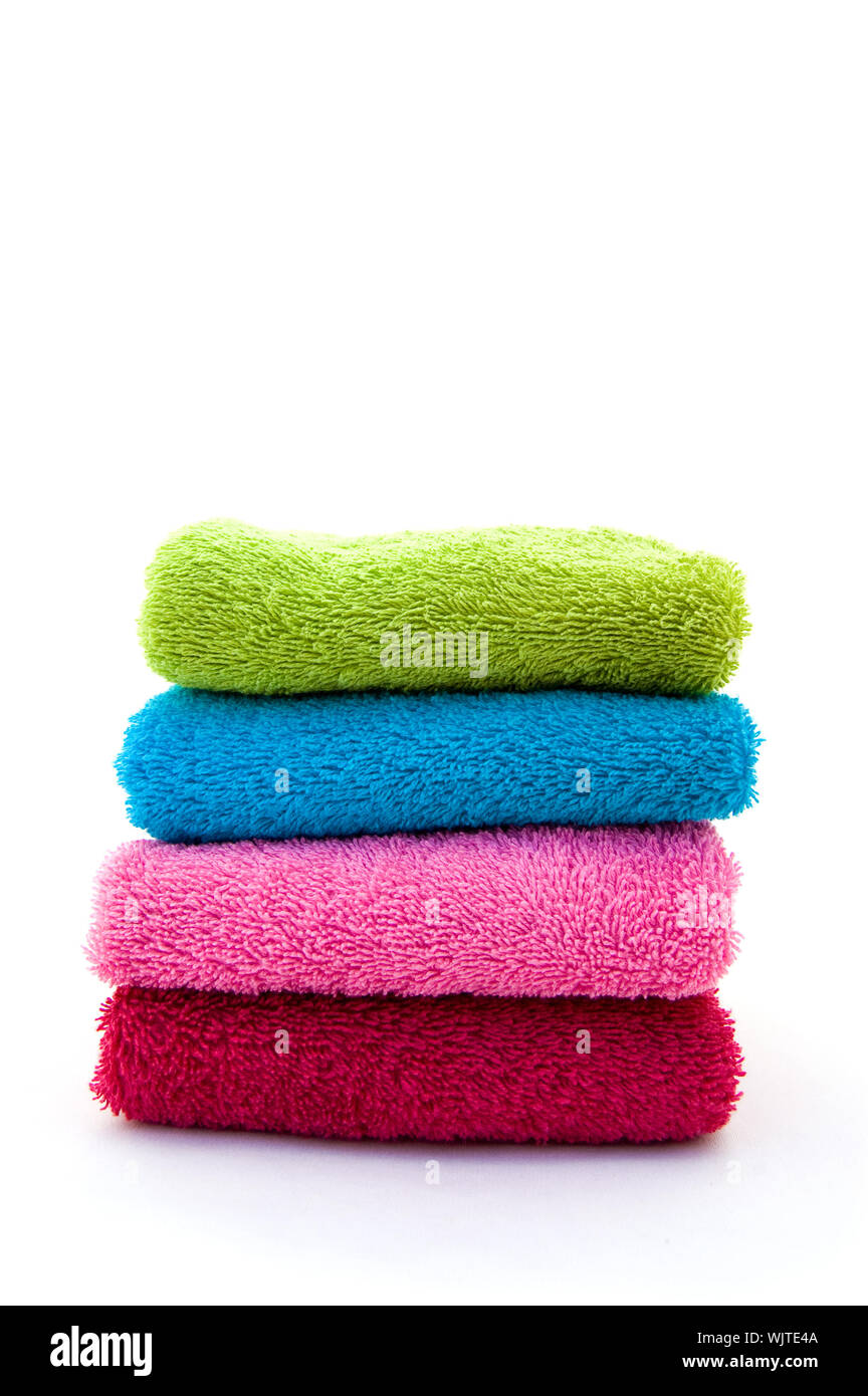 Stack of colorful towels on a white background Stock Photo - Alamy