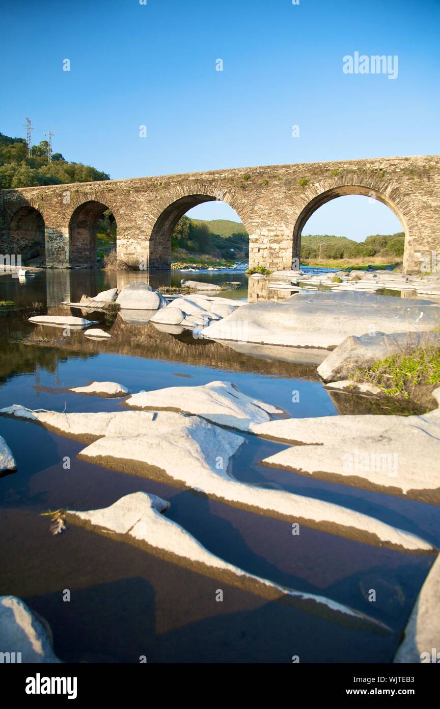 ancient stone bridge on a river in salamanca spain Stock Photo - Alamy
