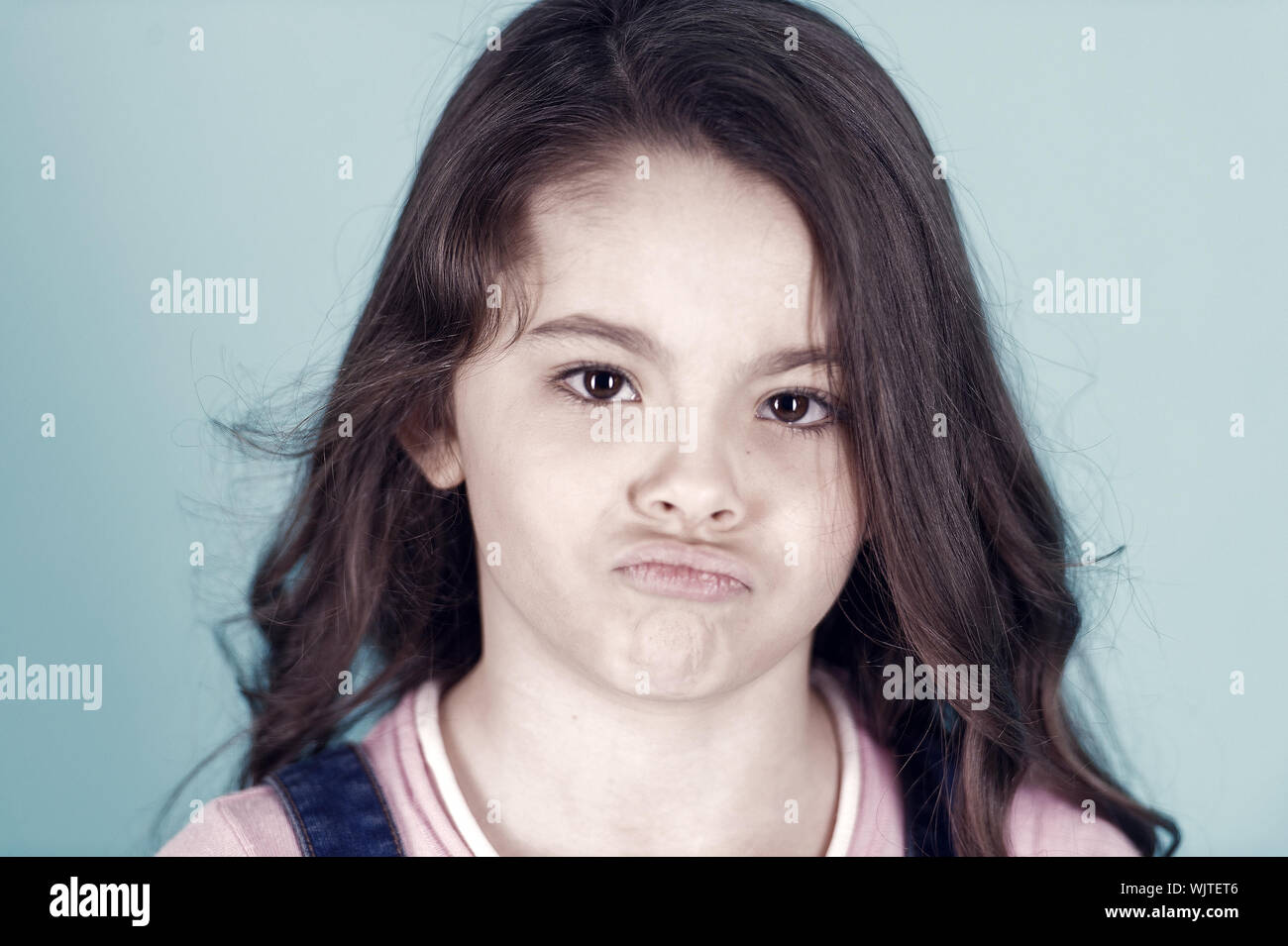 Beautiful girl looking sad with pouted lips. Cute kid with long hair ...