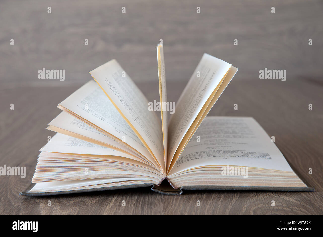 Open book on wood background Stock Photo - Alamy
