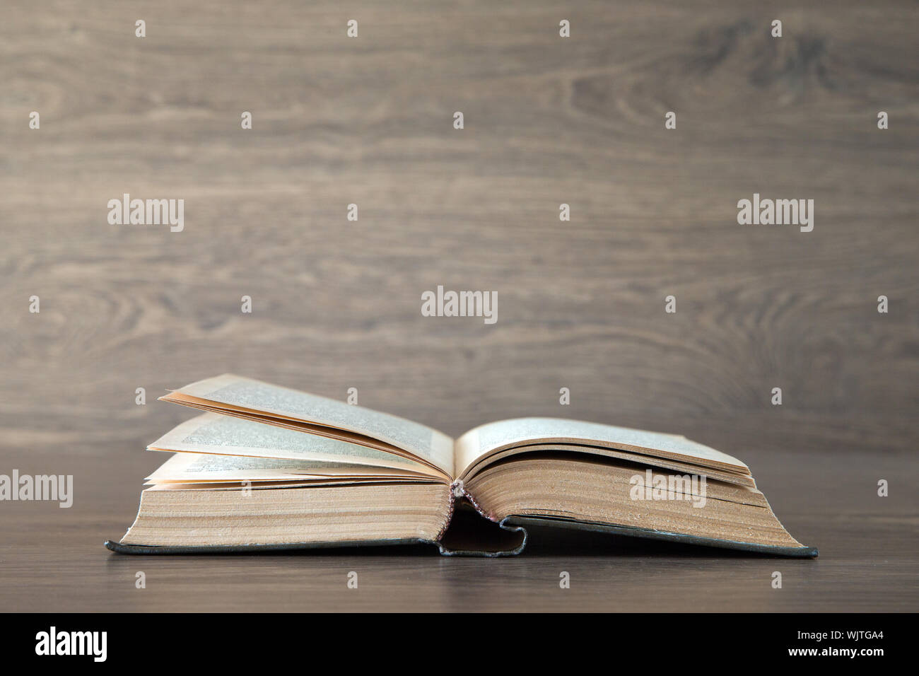 Open book on wood background Stock Photo - Alamy