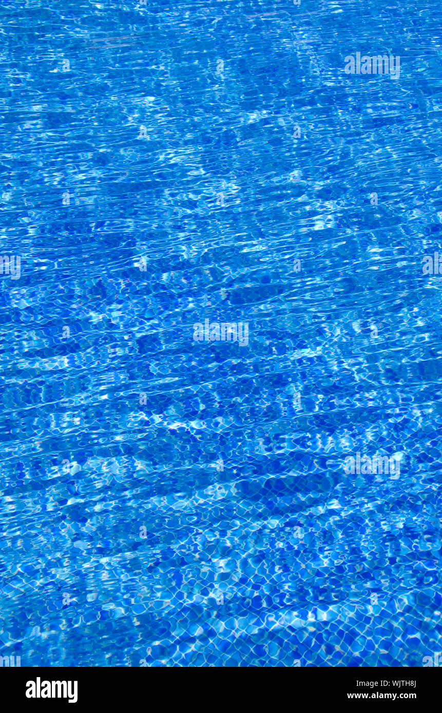 Blue pool water with sun reflections Stock Photo - Alamy