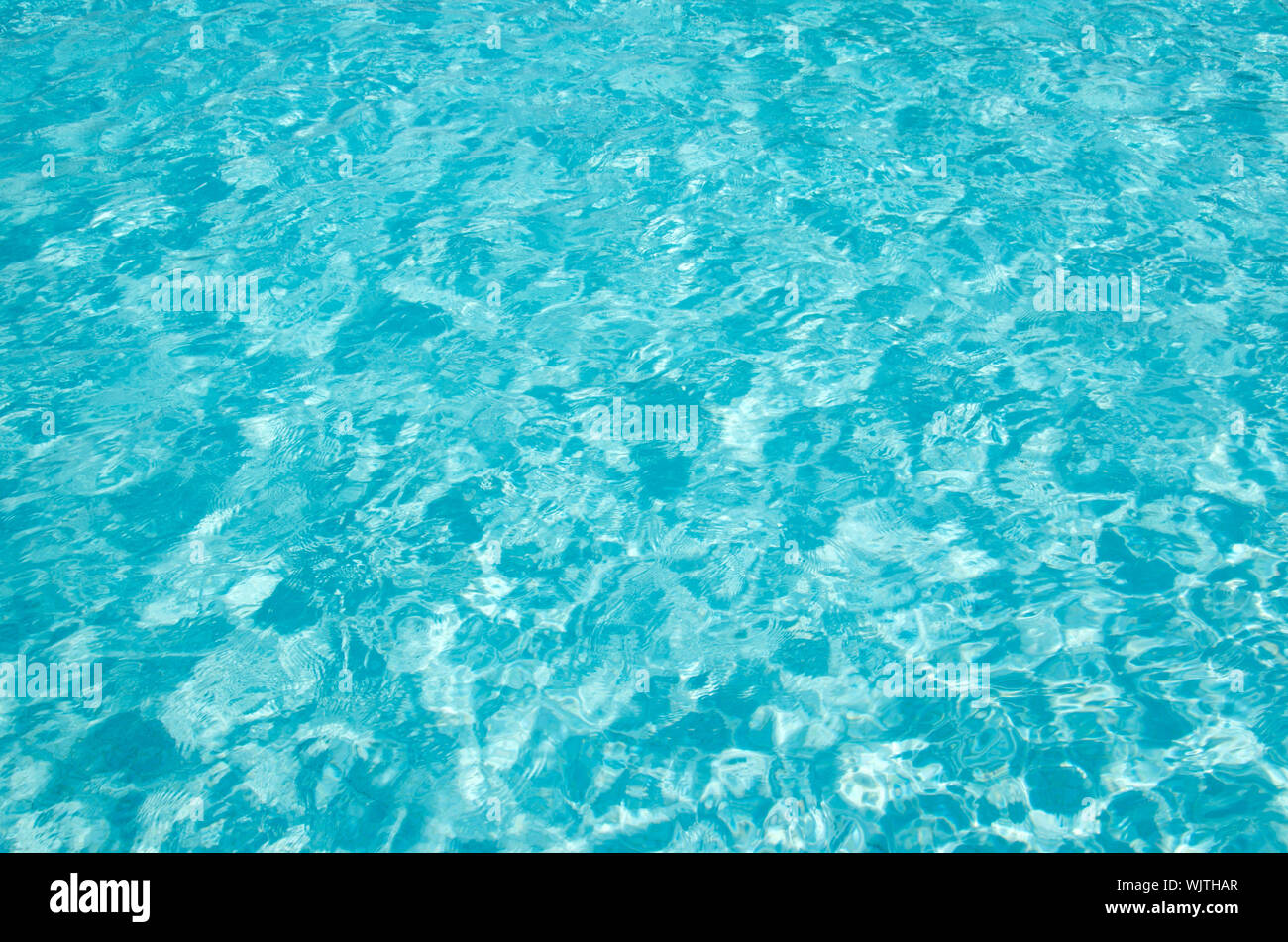 Blue pool water with sun reflections Stock Photo - Alamy