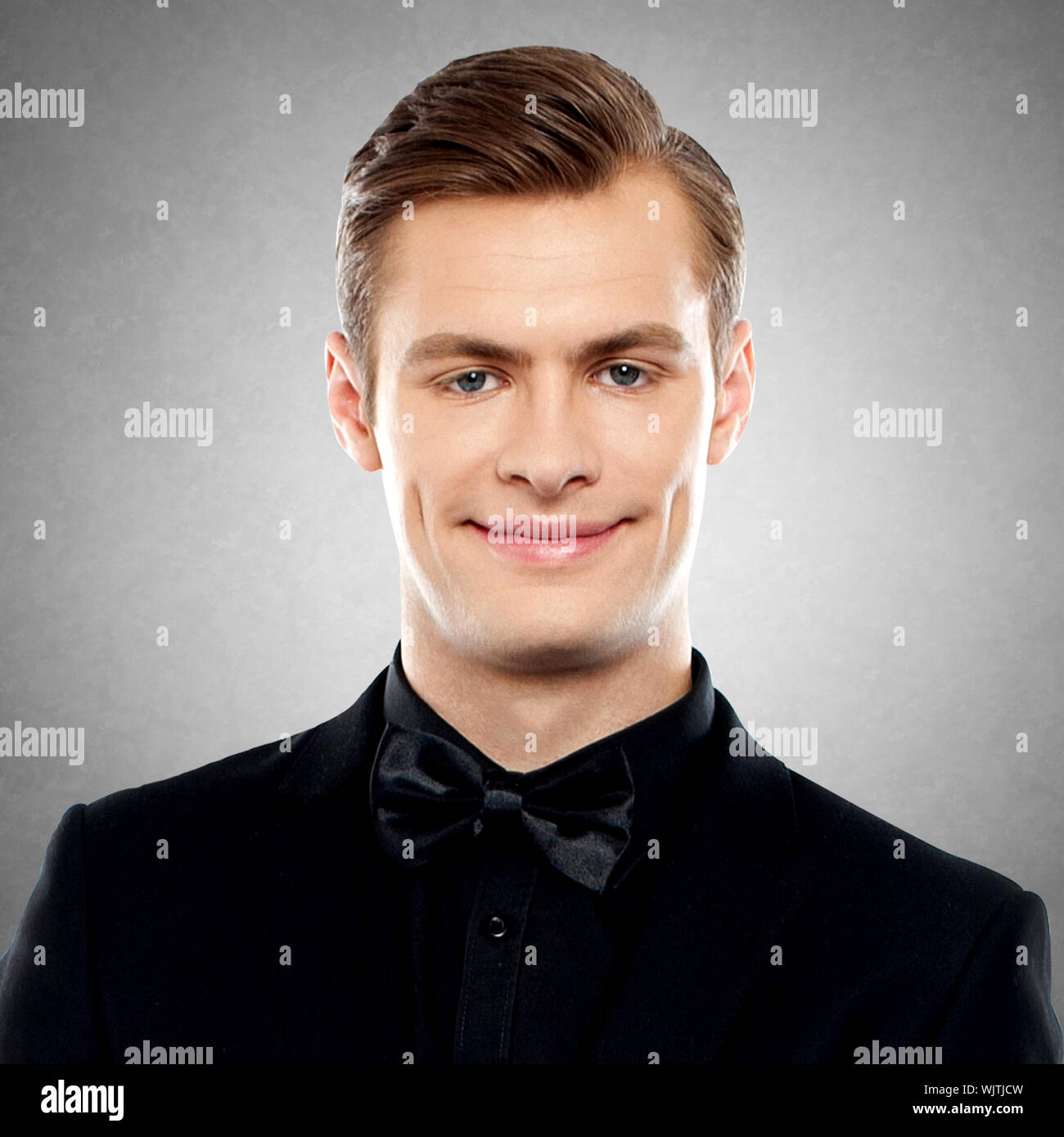 Smiling corporate guy posing with grey background Stock Photo - Alamy